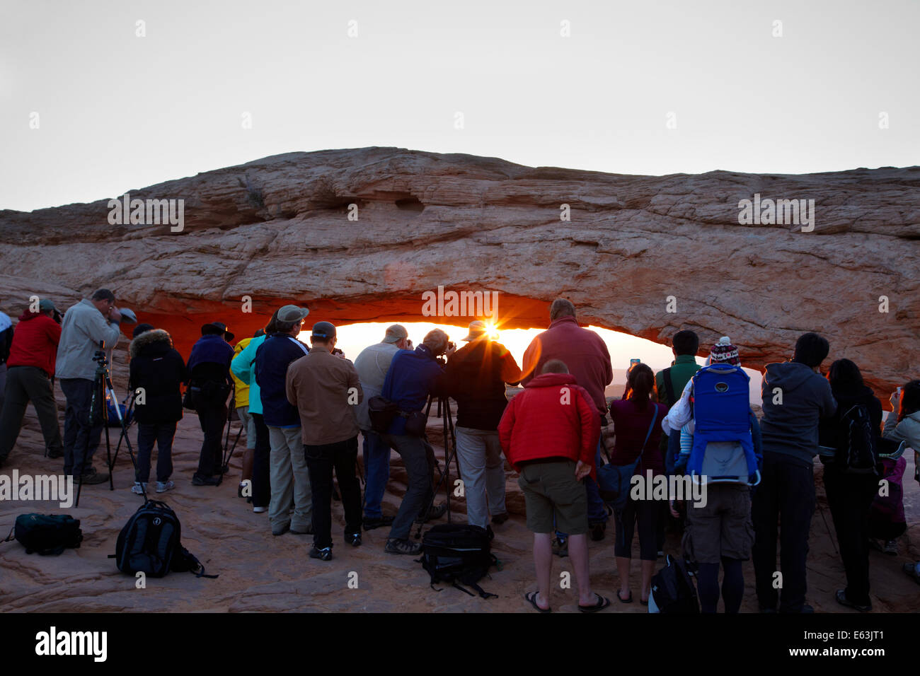 Crowd of photographers shooting sunrise under Mesa Arch, Canyonlands ...