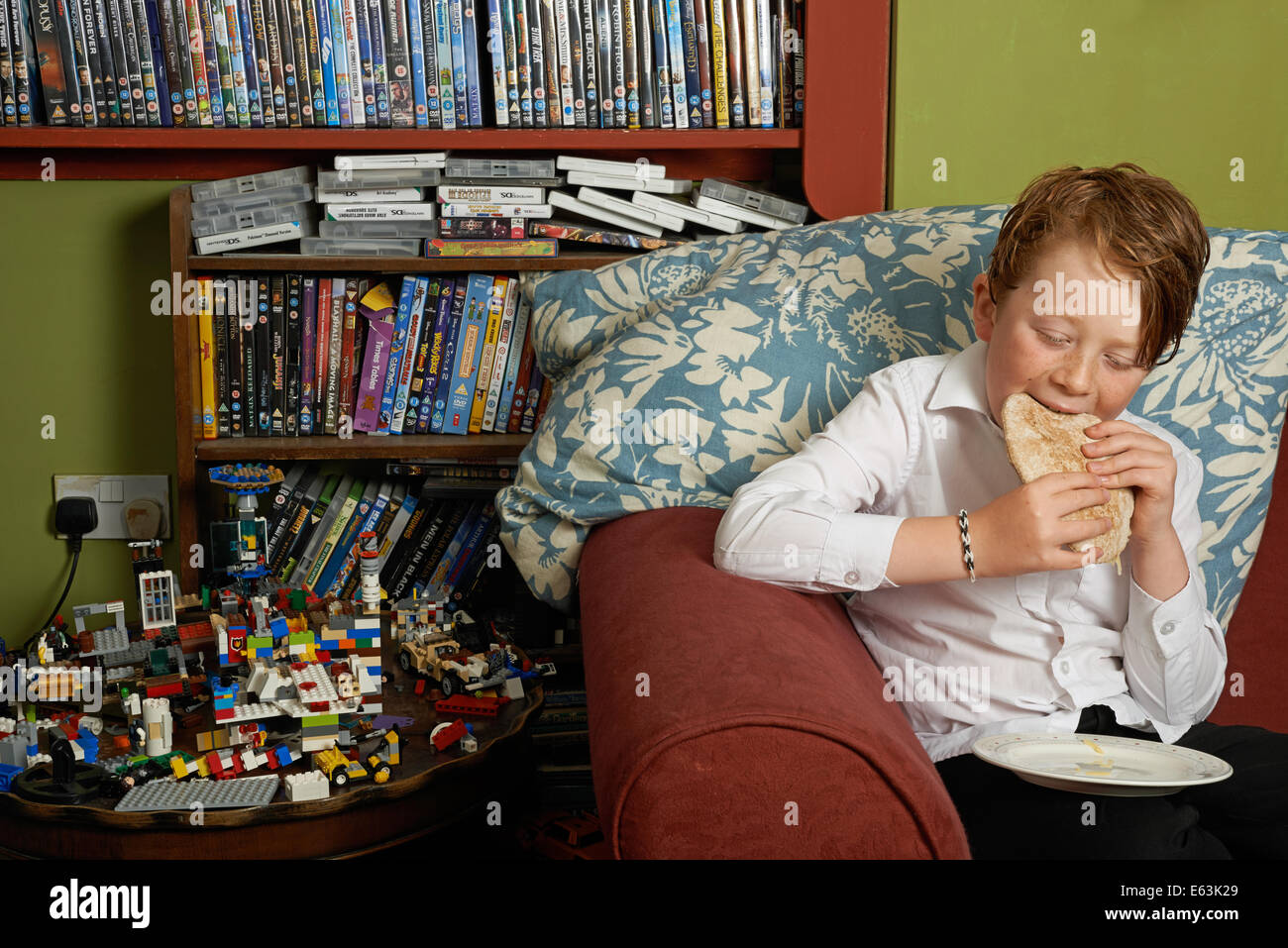 Schoolboy home alone eating a pita bread sandwich Stock Photo - Alamy