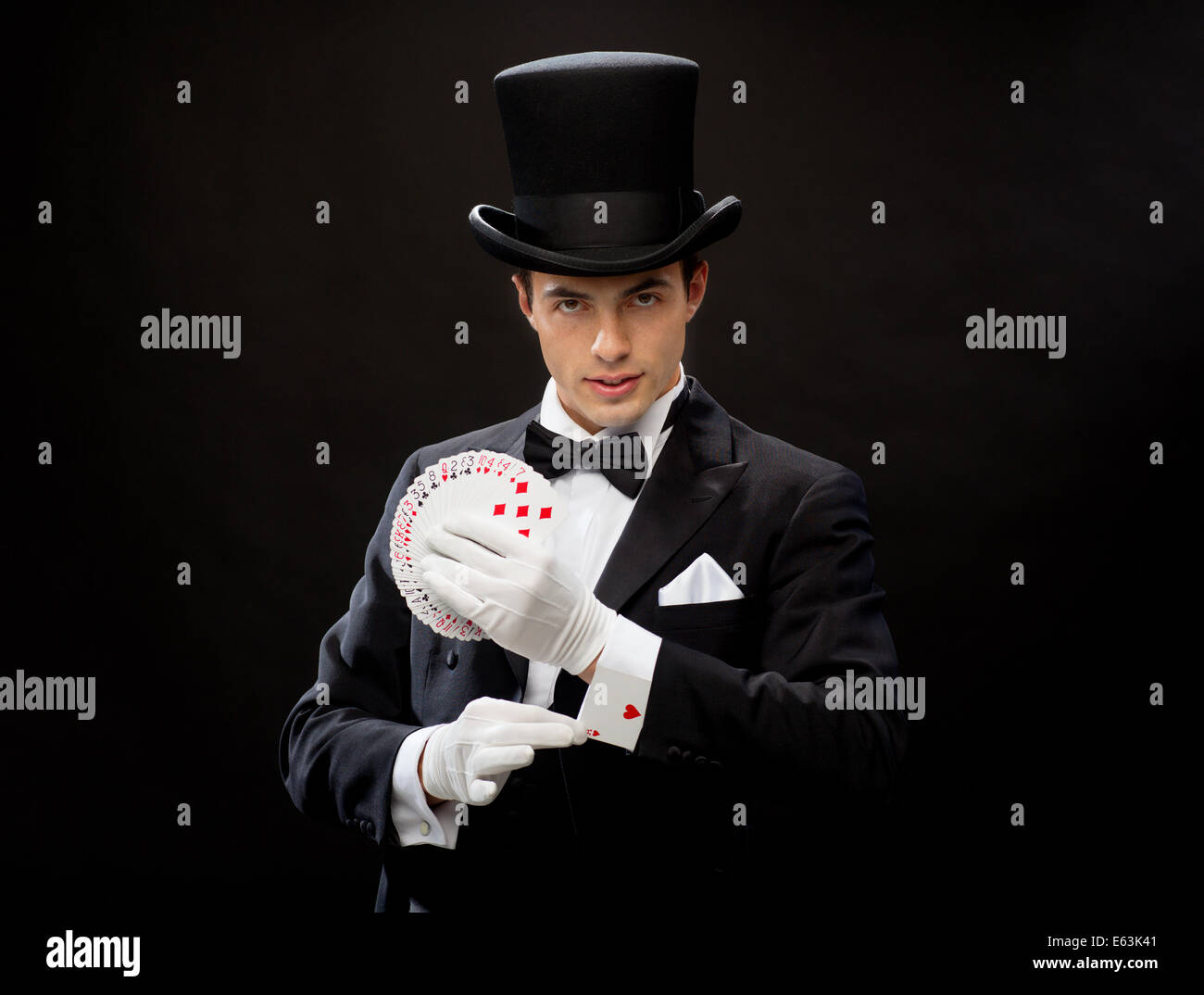 magician showing trick with playing cards Stock Photo - Alamy
