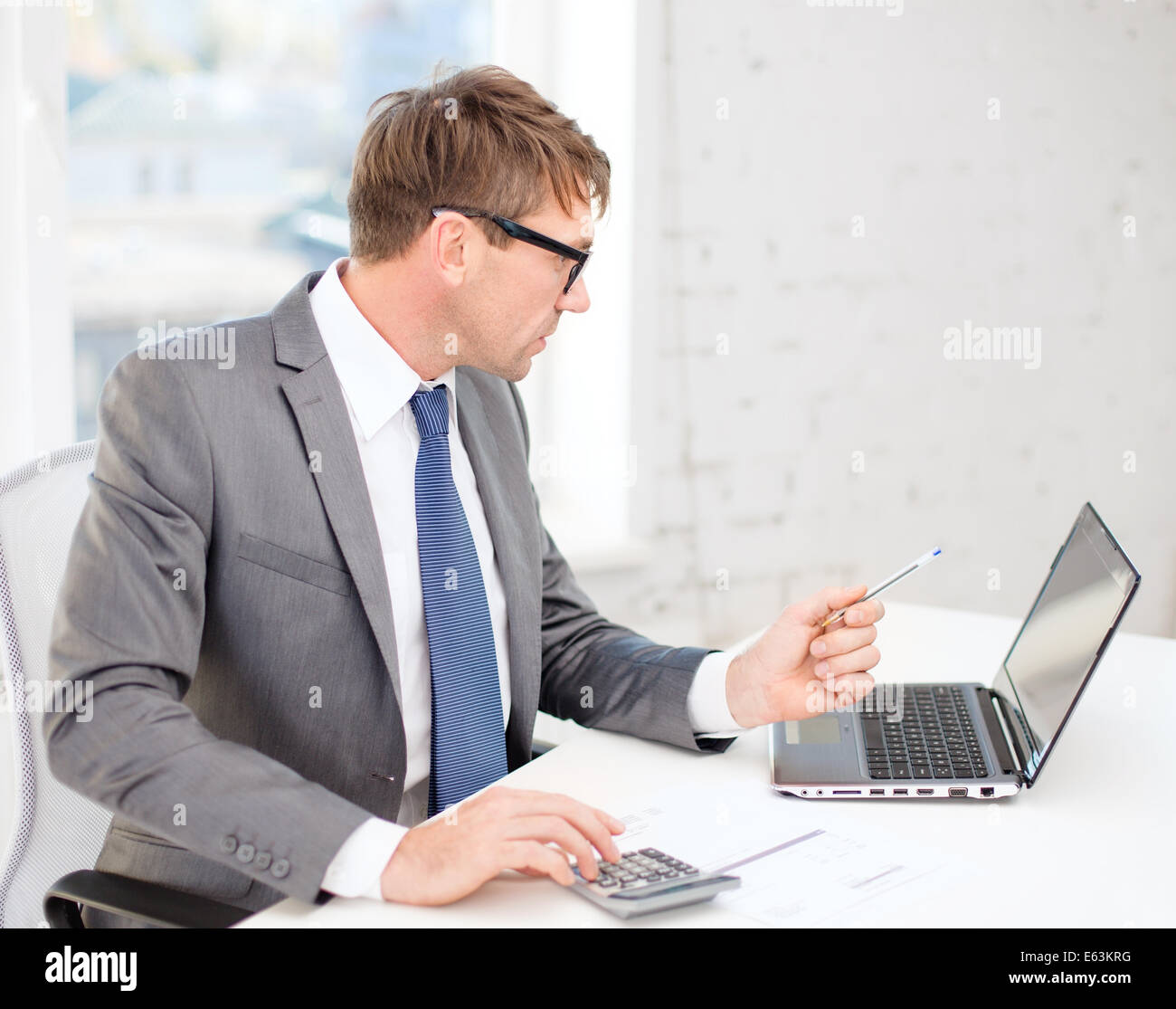 businessman with computer, papers and calculator Stock Photo - Alamy