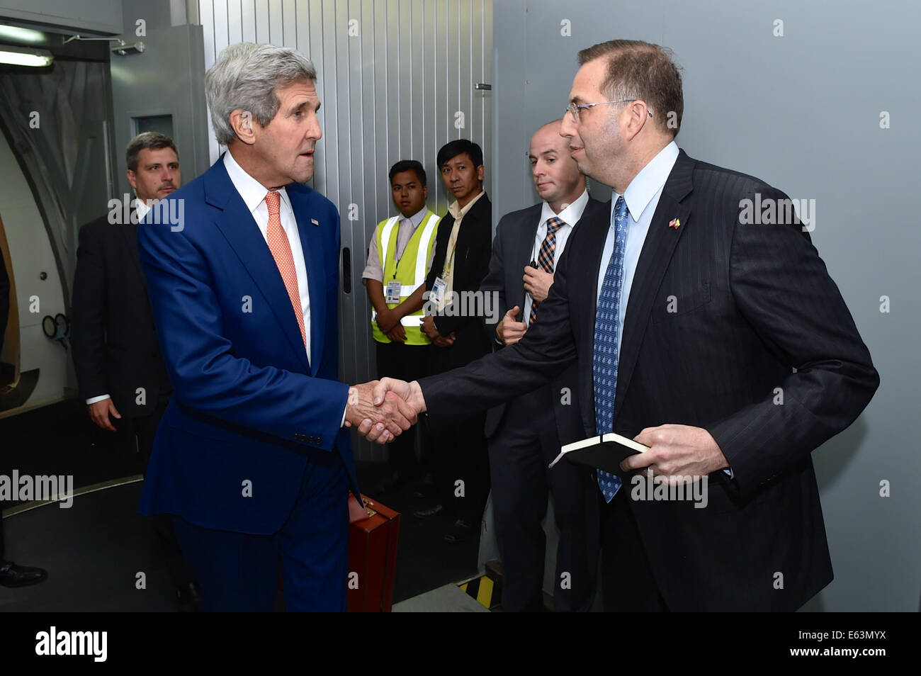 U.S. Ambassador to Burma Derek Mitchell greets U.S. Secretary of State John Kerry upon his ...