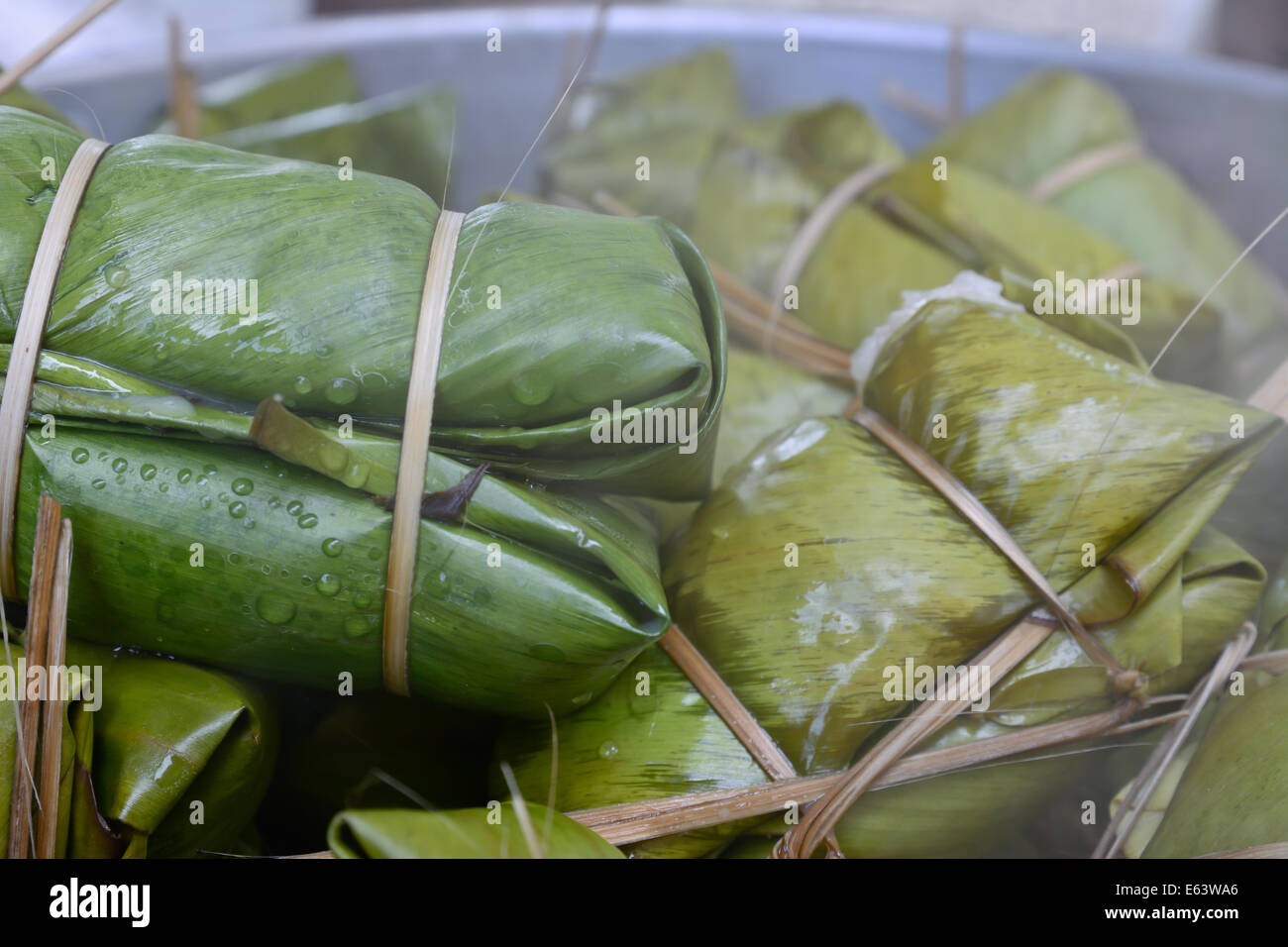 closeup of glutinous rice steamed in banana leaf in steam pot ...