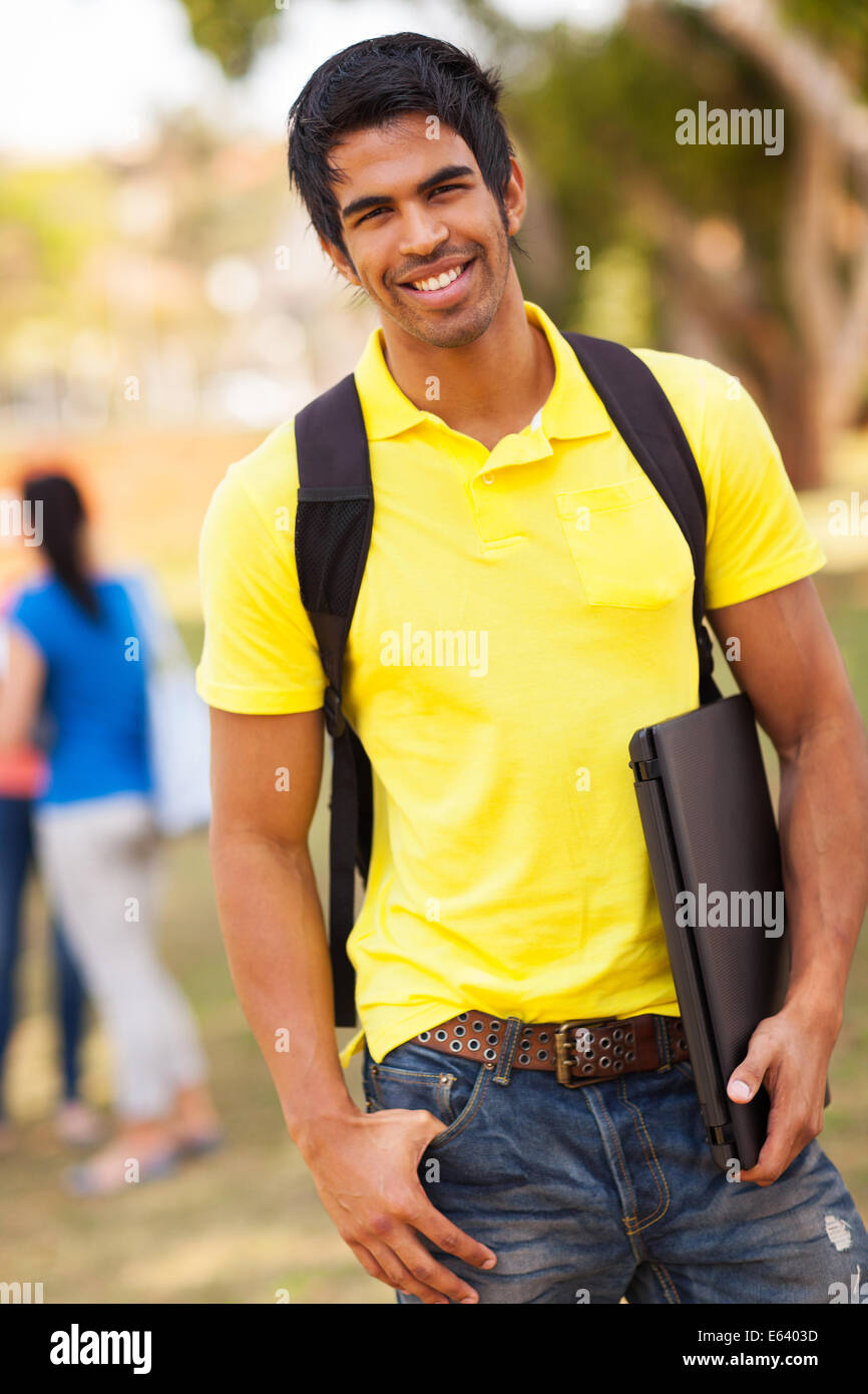 handsome male Indian university student standing outdoors on campus ...