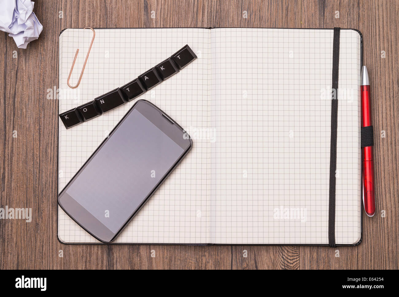 Image shows an empty opened notebook with mobile and set of letters ...