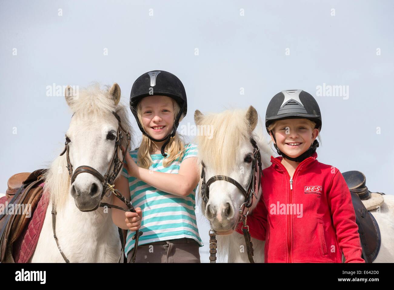 Two girls on ponies riding hi-res stock photography and images - Alamy