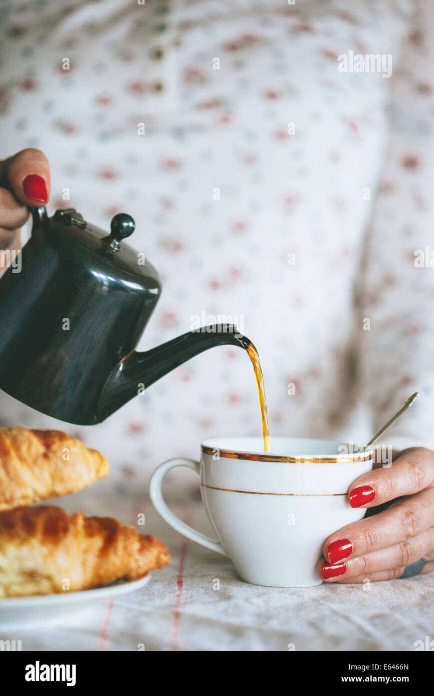 Woman pouring her morning coffee/tea Stock Photo - Alamy
