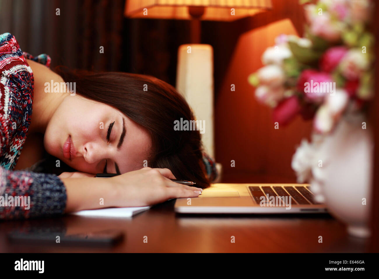 Tired woman sleeping on the table at home Stock Photo - Alamy