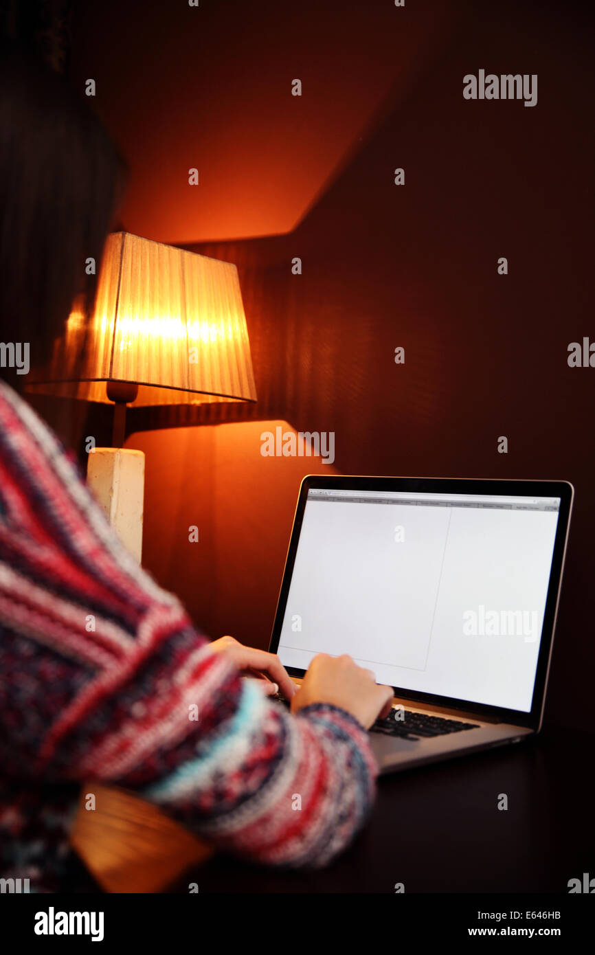 Back view portrait of a woman using laptop at home Stock Photo - Alamy