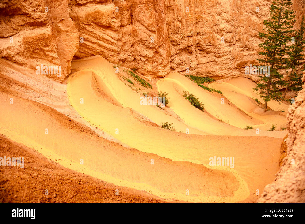 A summer rainstorm sends water cascading down the steep switchbacks on ...