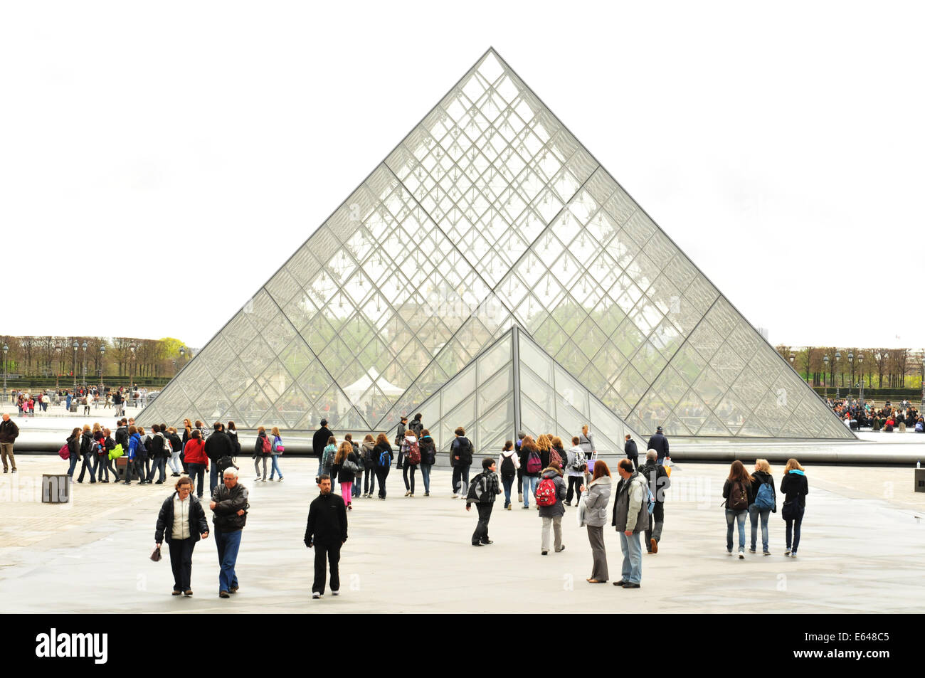 PARIS, FRANCE - MARCH 29, 2011: Tourists visit glass pyramid in the ...