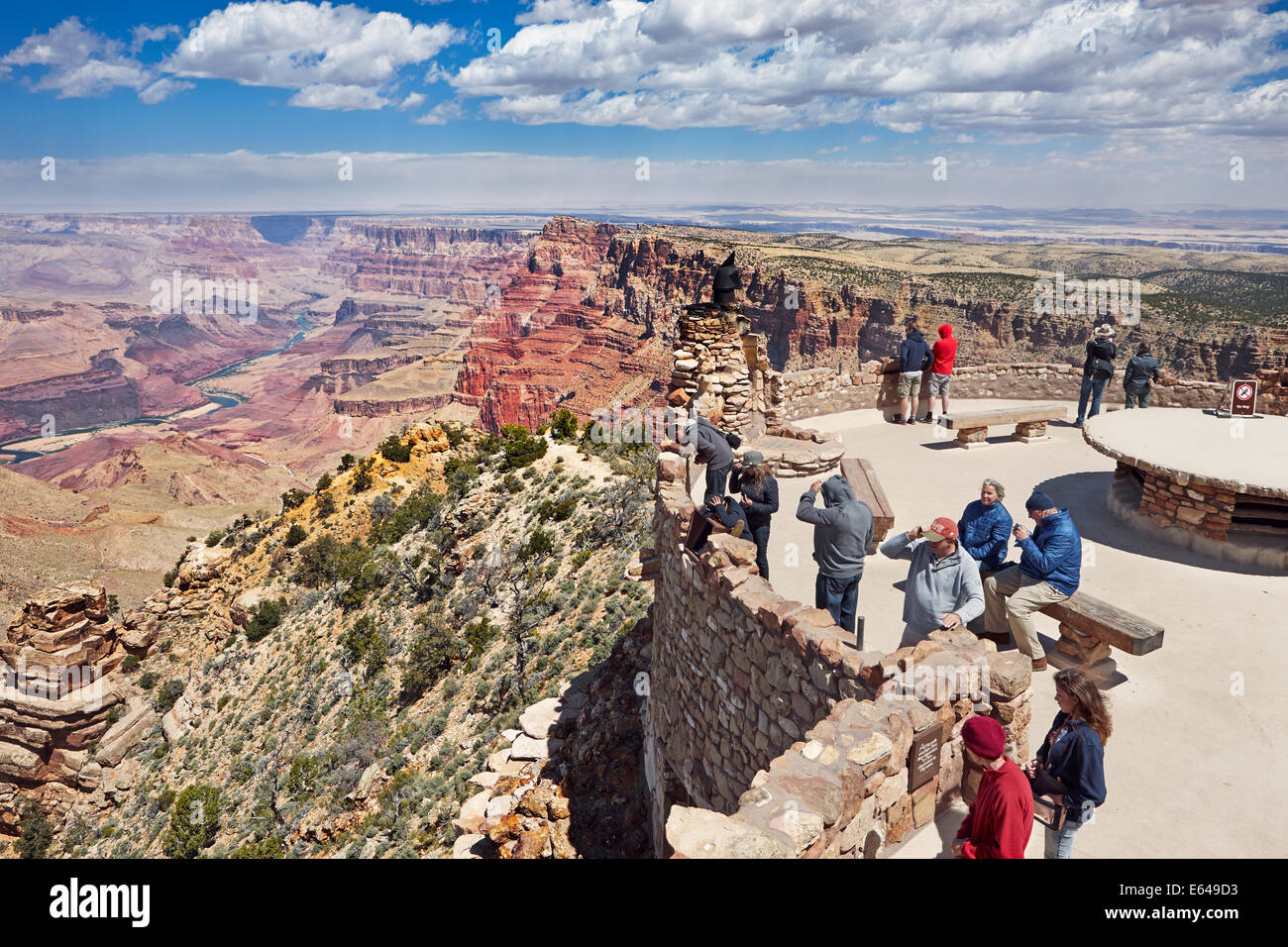 Tourists enjoy the magnificent view of the Grand Canyon from a ...