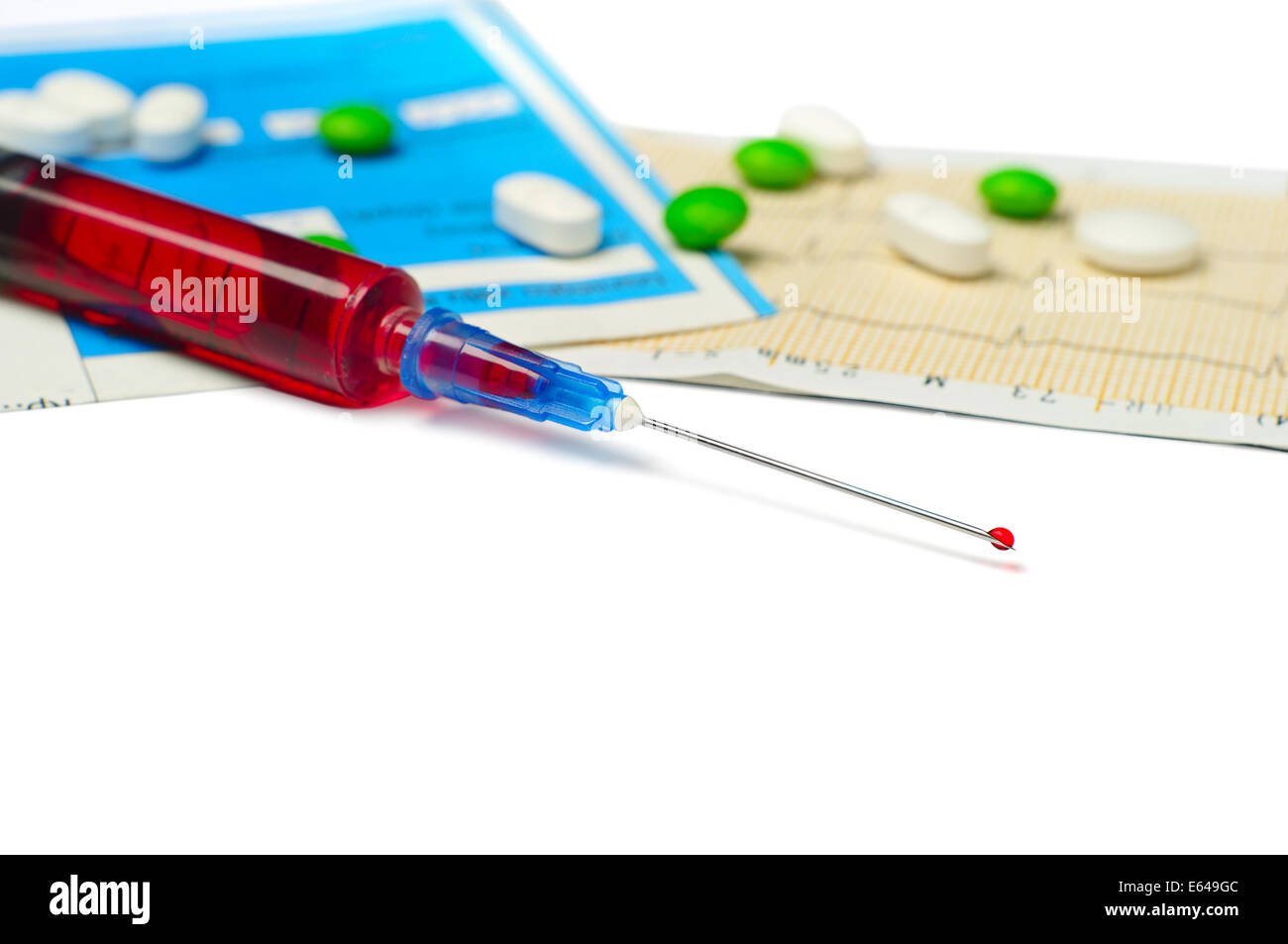 Medical syringe and tablets on white Stock Photo - Alamy
