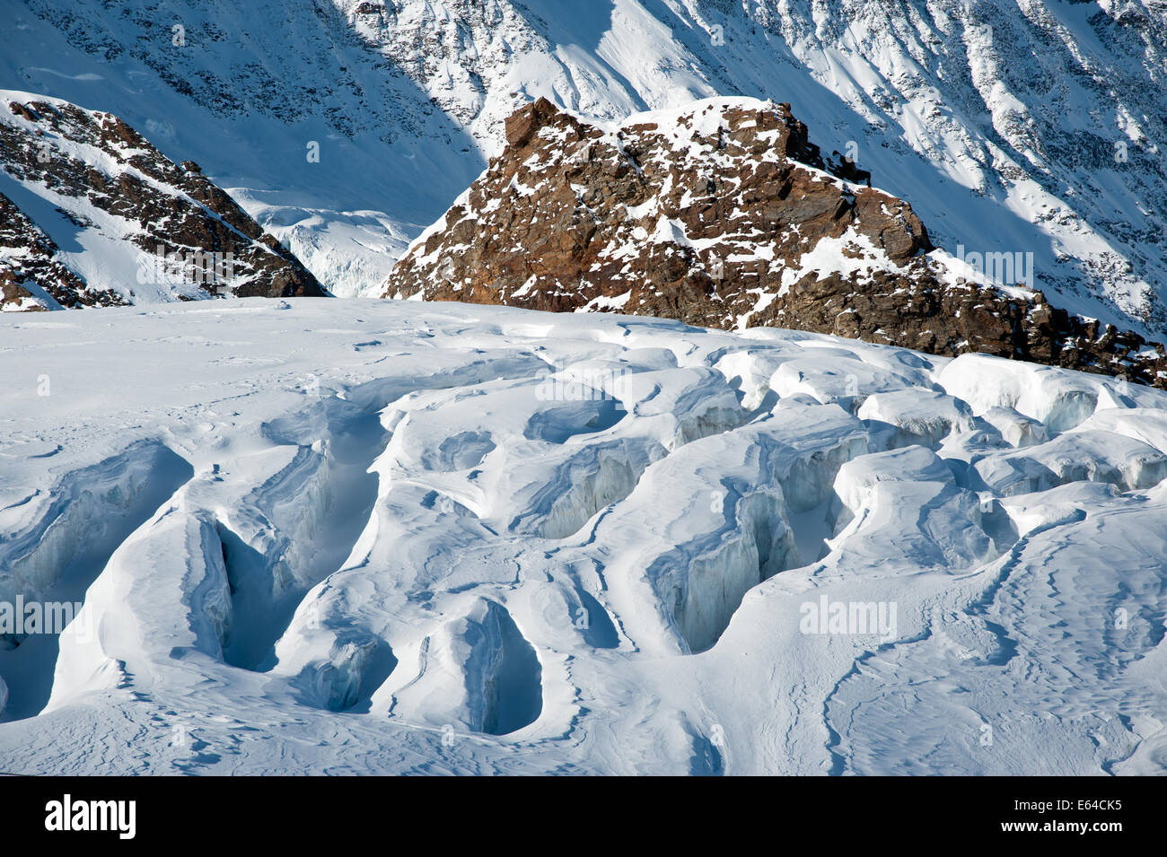 Snow covered glacier with crevasses and seracs in the region of Saas ...