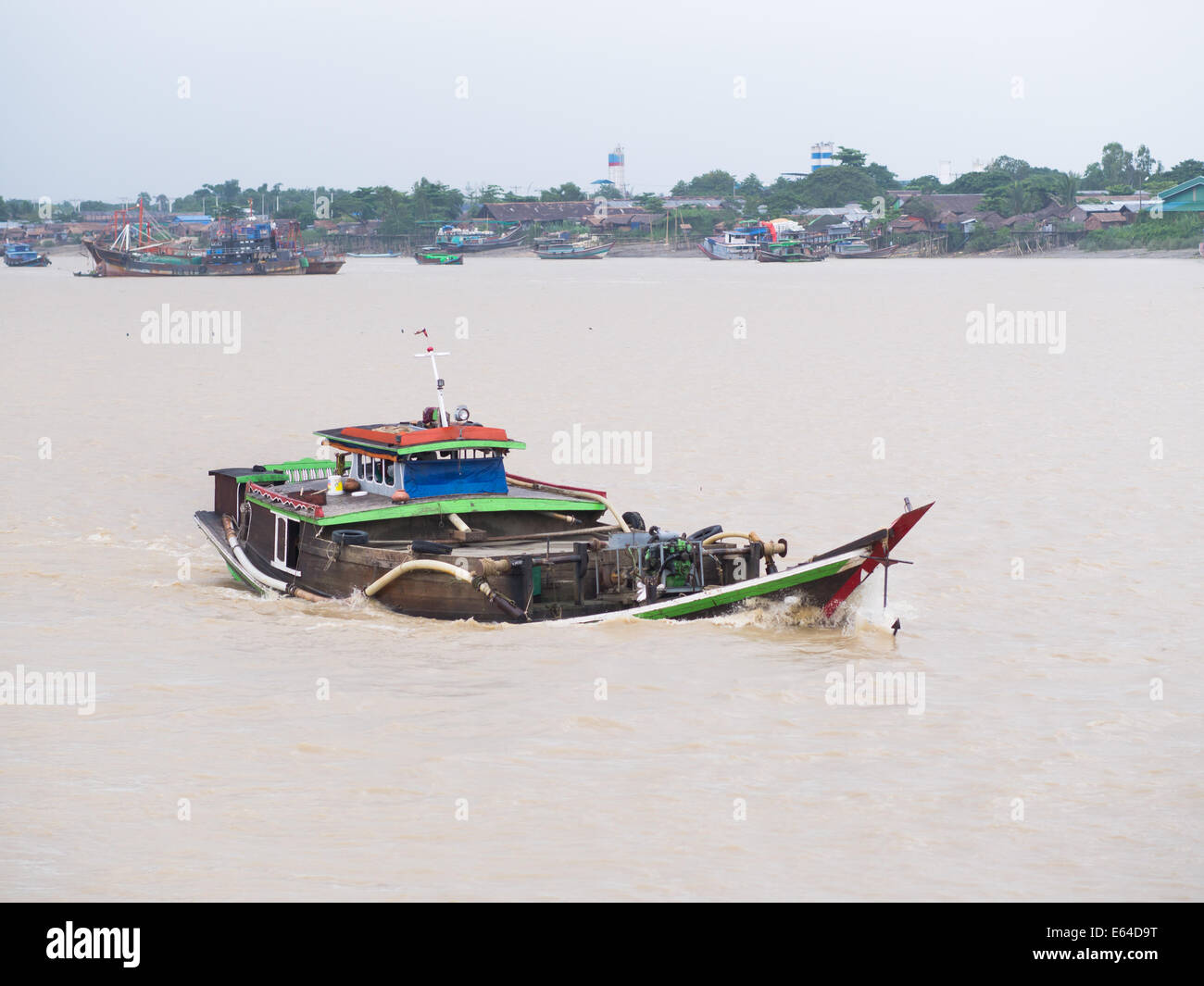 Traditional, wooden Burmese cargo vessel, fully loaded, on Yangon River ...