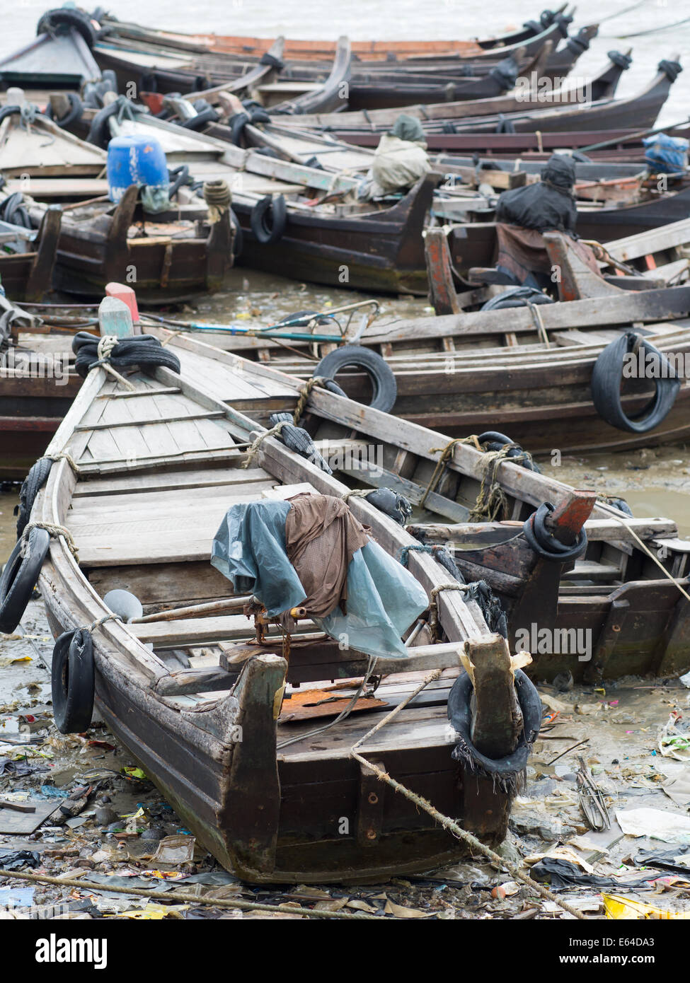 Traditional wooden boat along the polluted seaside at Myeik in southern ...