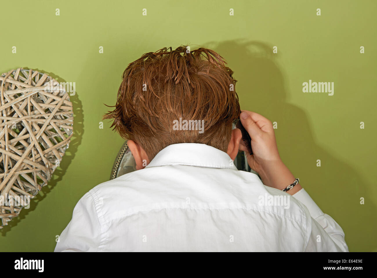 Boy combing his hair hi-res stock photography and images - Alamy