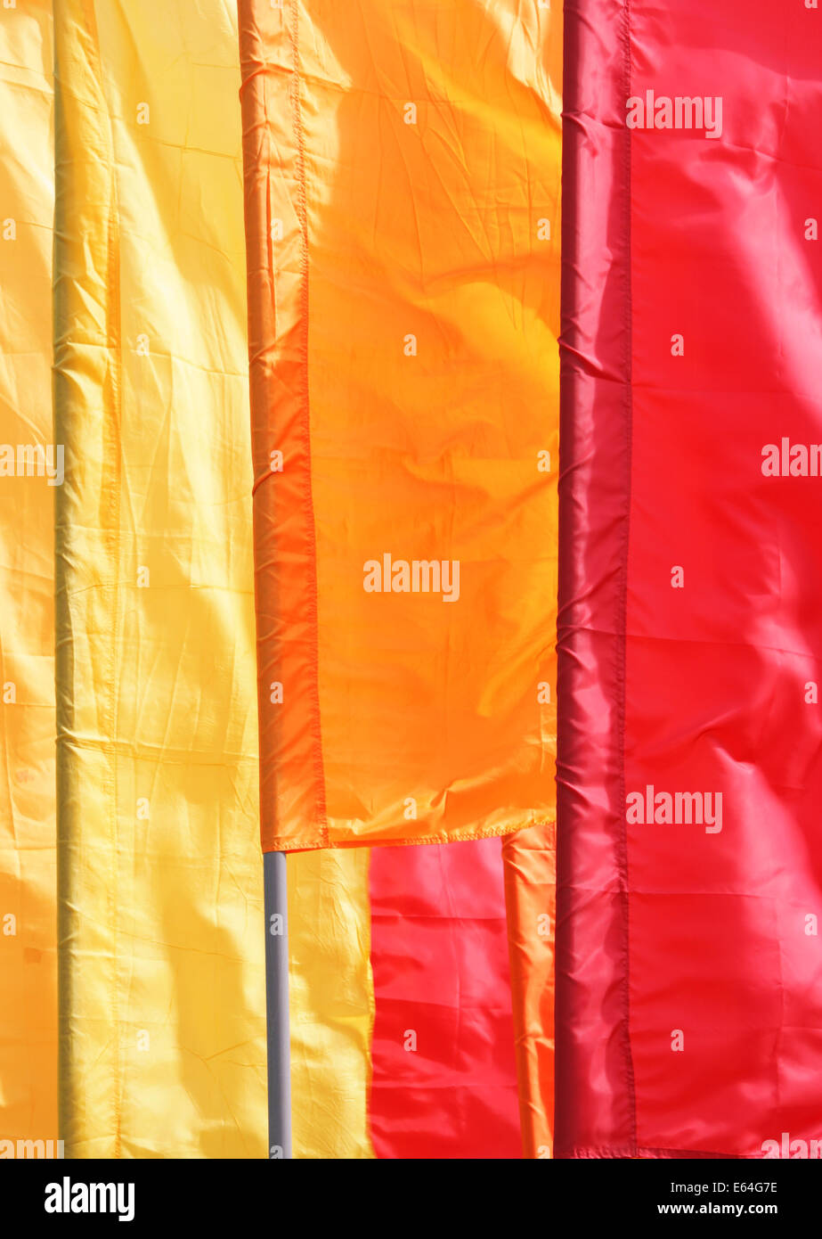 Yellow and red flags in wind, may be used as background Stock Photo - Alamy