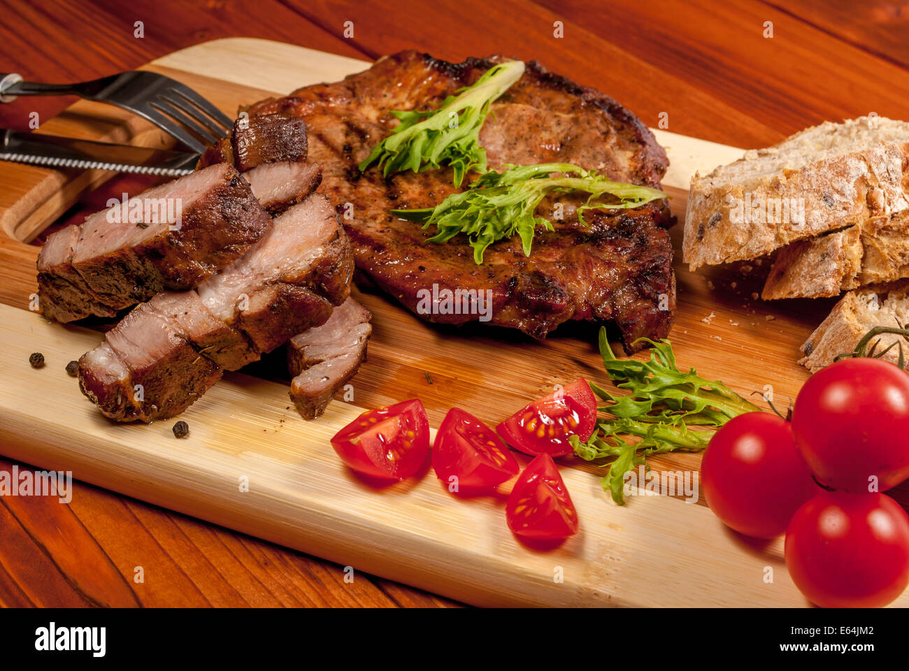 Pork neck steak with vegetables and pepper Stock Photo - Alamy