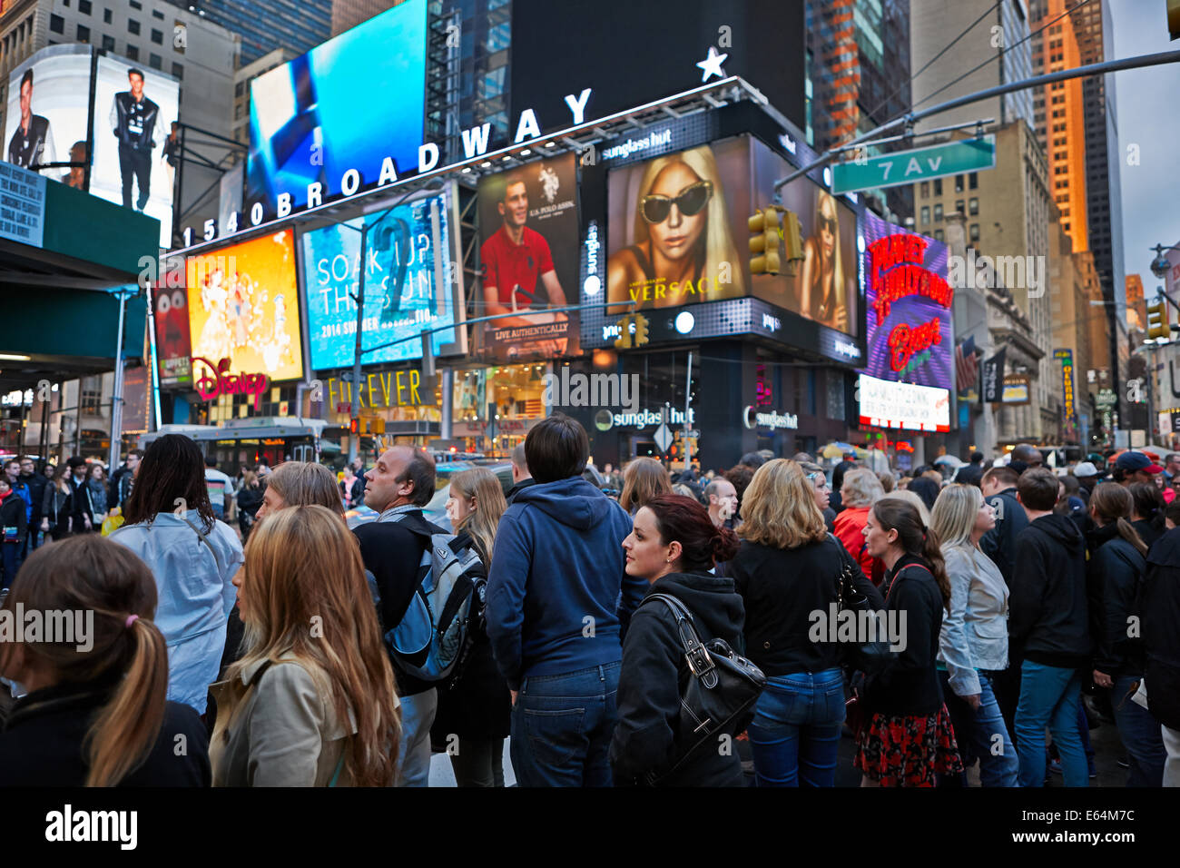 Crowd of people walking in the Times Square at dusk. New York, USA ...
