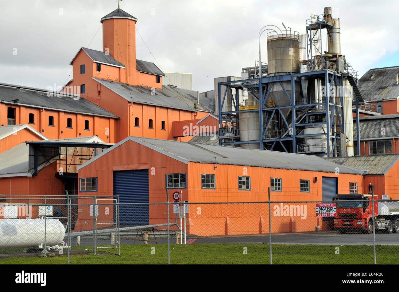 Red factory buildings, silos and other plants of Chelsea Sugar refinery ...