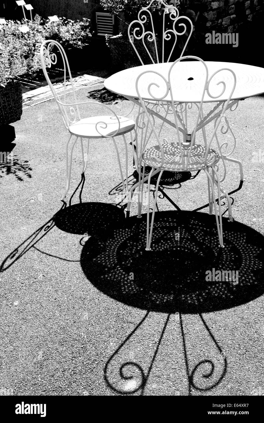 High contrast Black and White image of cafe style table and chairs at ...