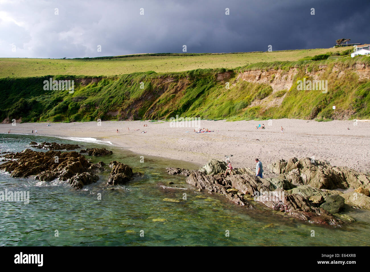 A moody Landscape of Portwrinkle beach, Devon, UK showing green cliffs ...