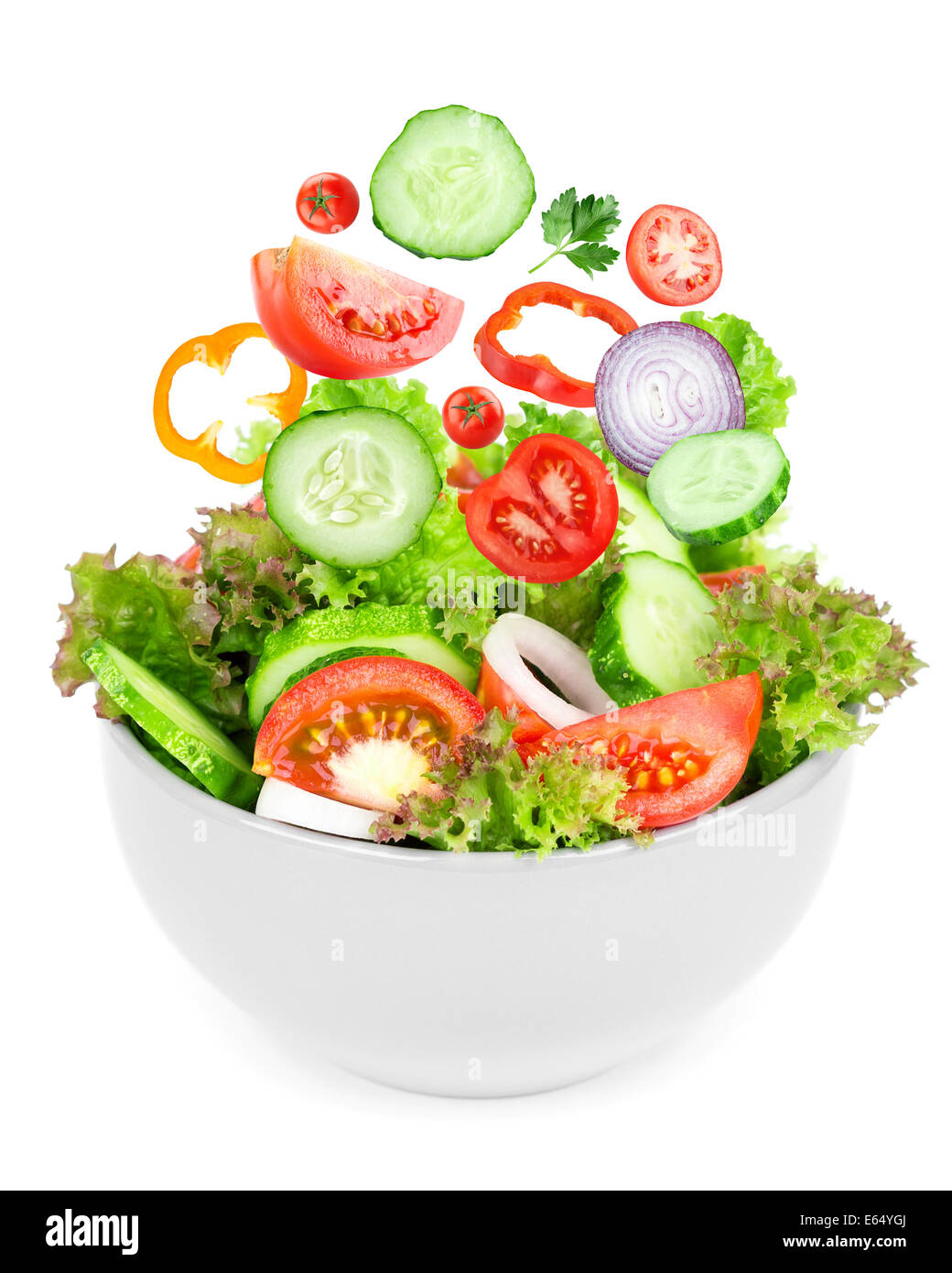 Fresh salad. Mixed falling vegetables in bowl on white background Stock ...