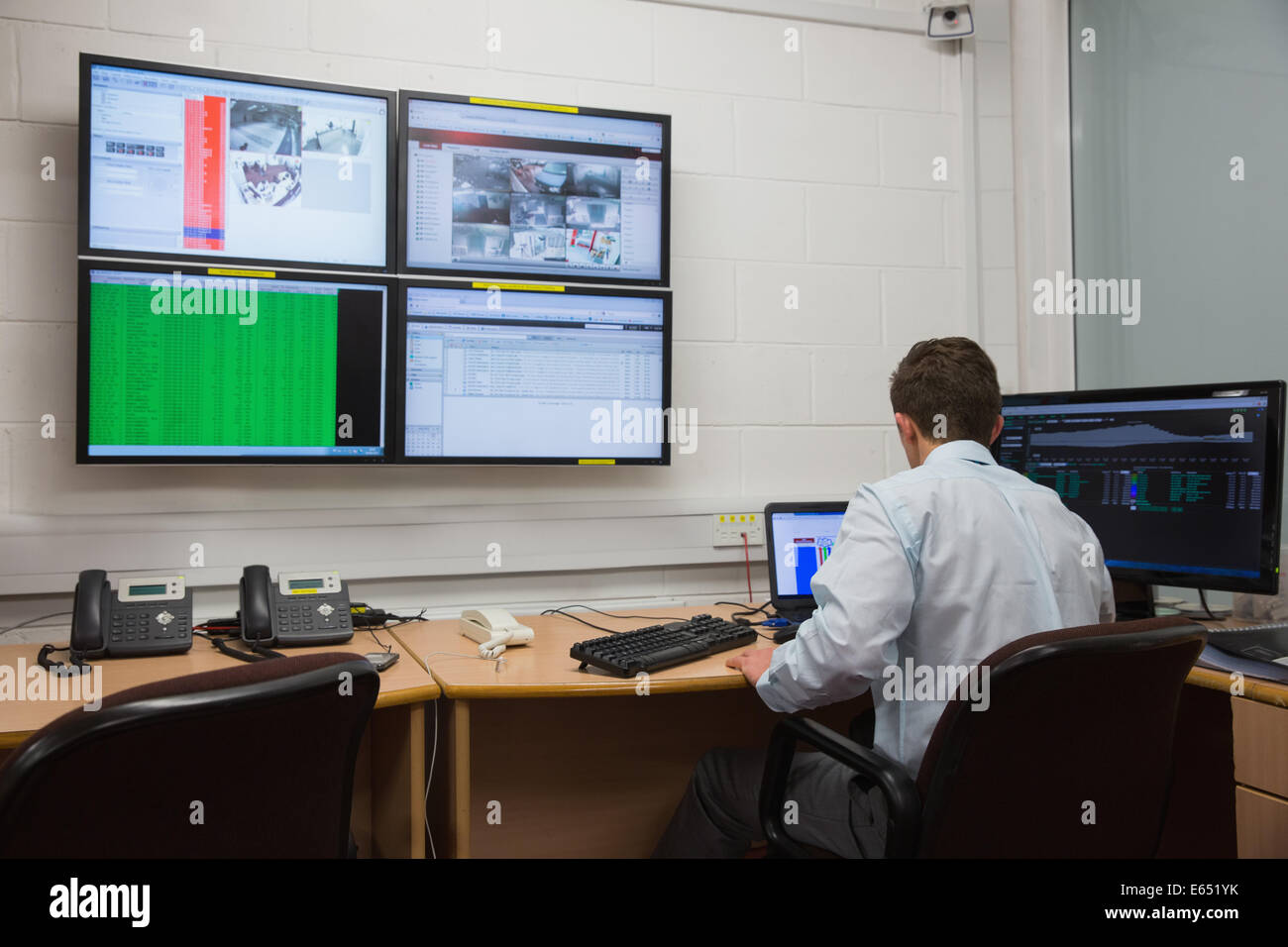 Technician sitting in office running diagnostics Stock Photo - Alamy