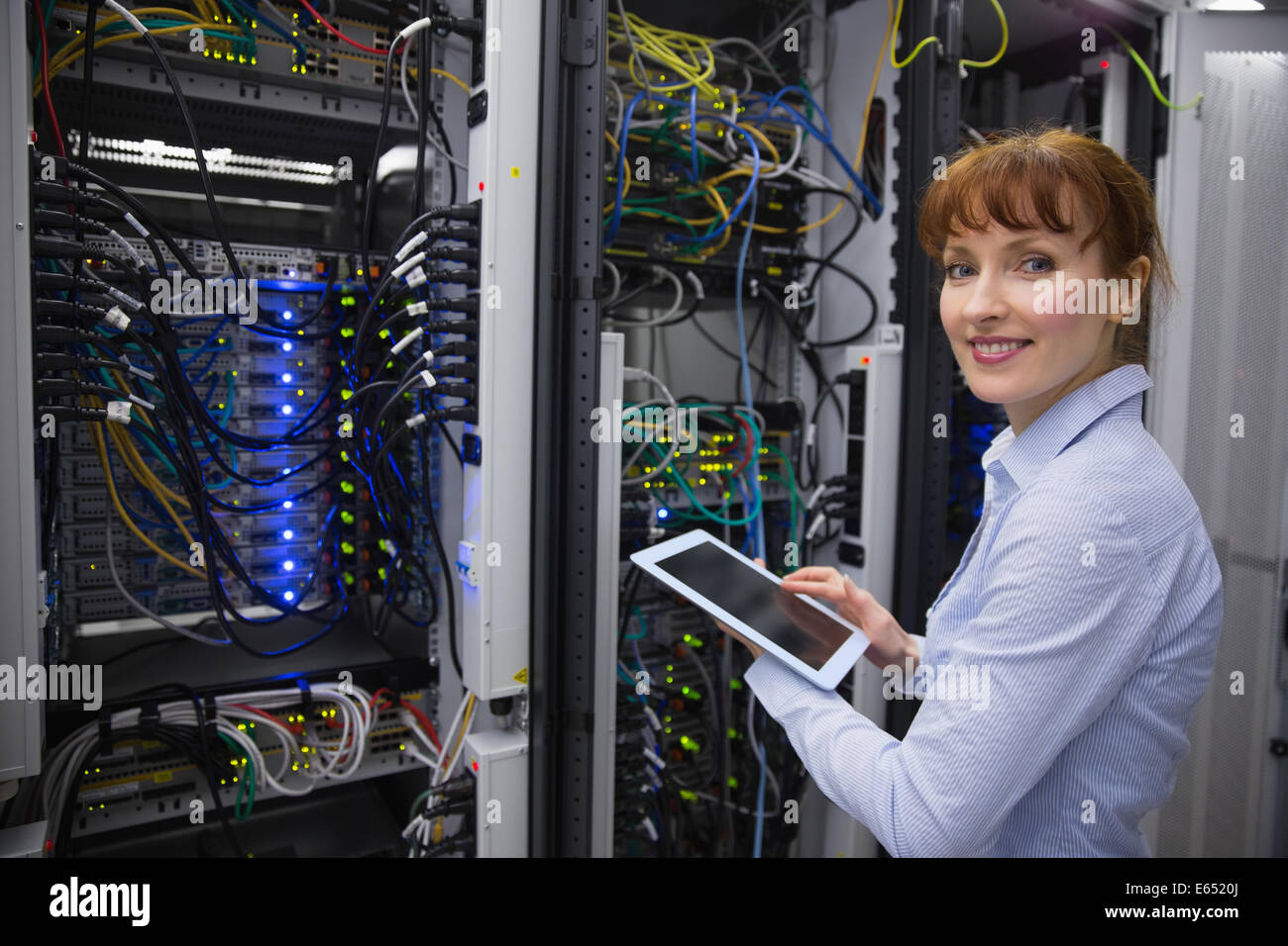 Smiling technician using tablet hi-res stock photography and images - Alamy