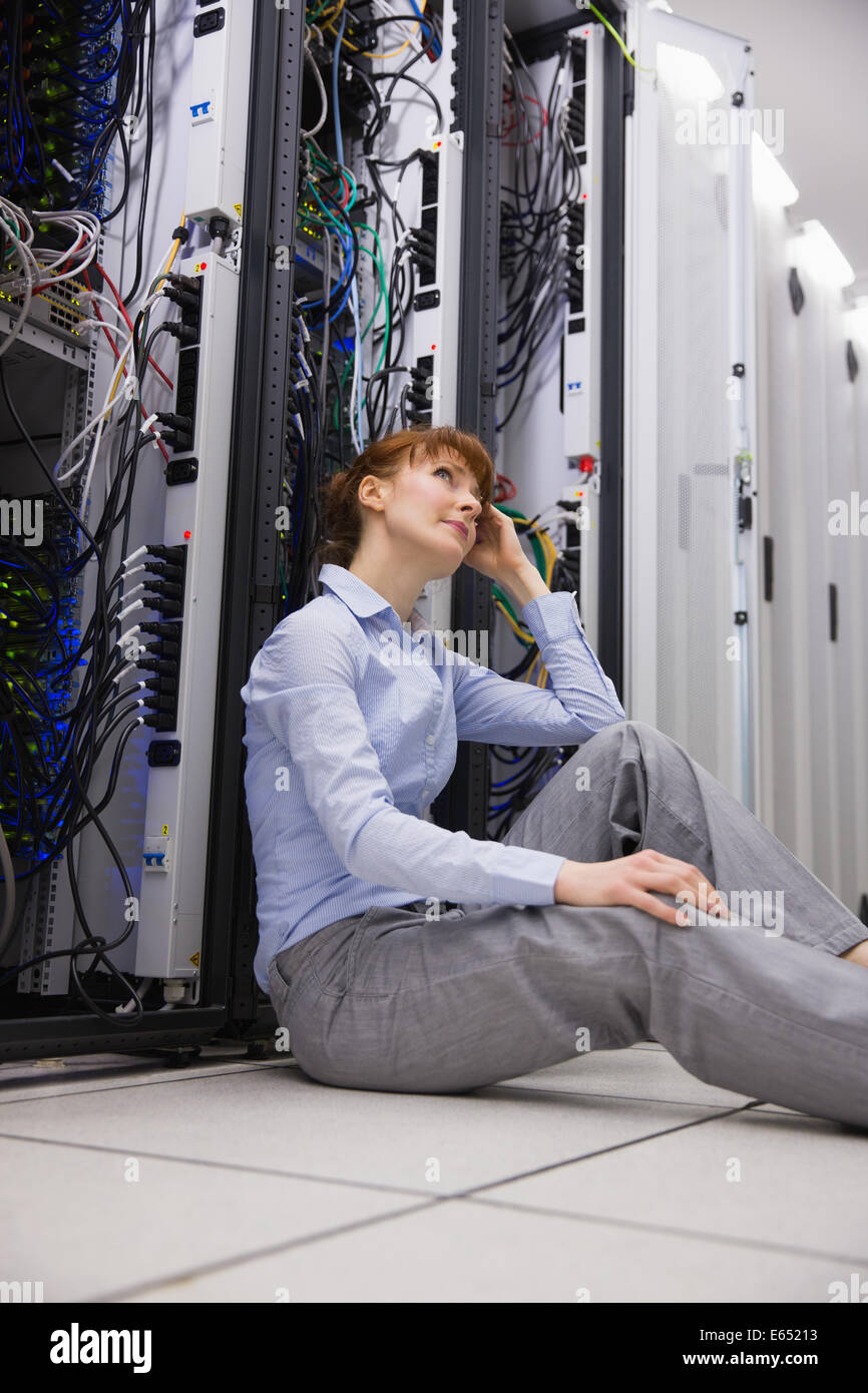 Stressed technician sitting on floor beside open server Stock Photo - Alamy
