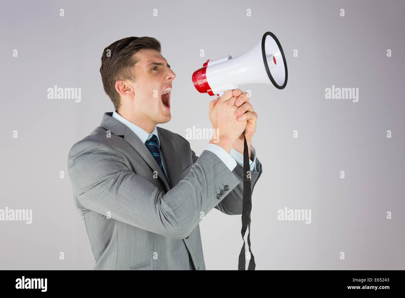 Angry businessman shouting through megaphone Stock Photo - Alamy