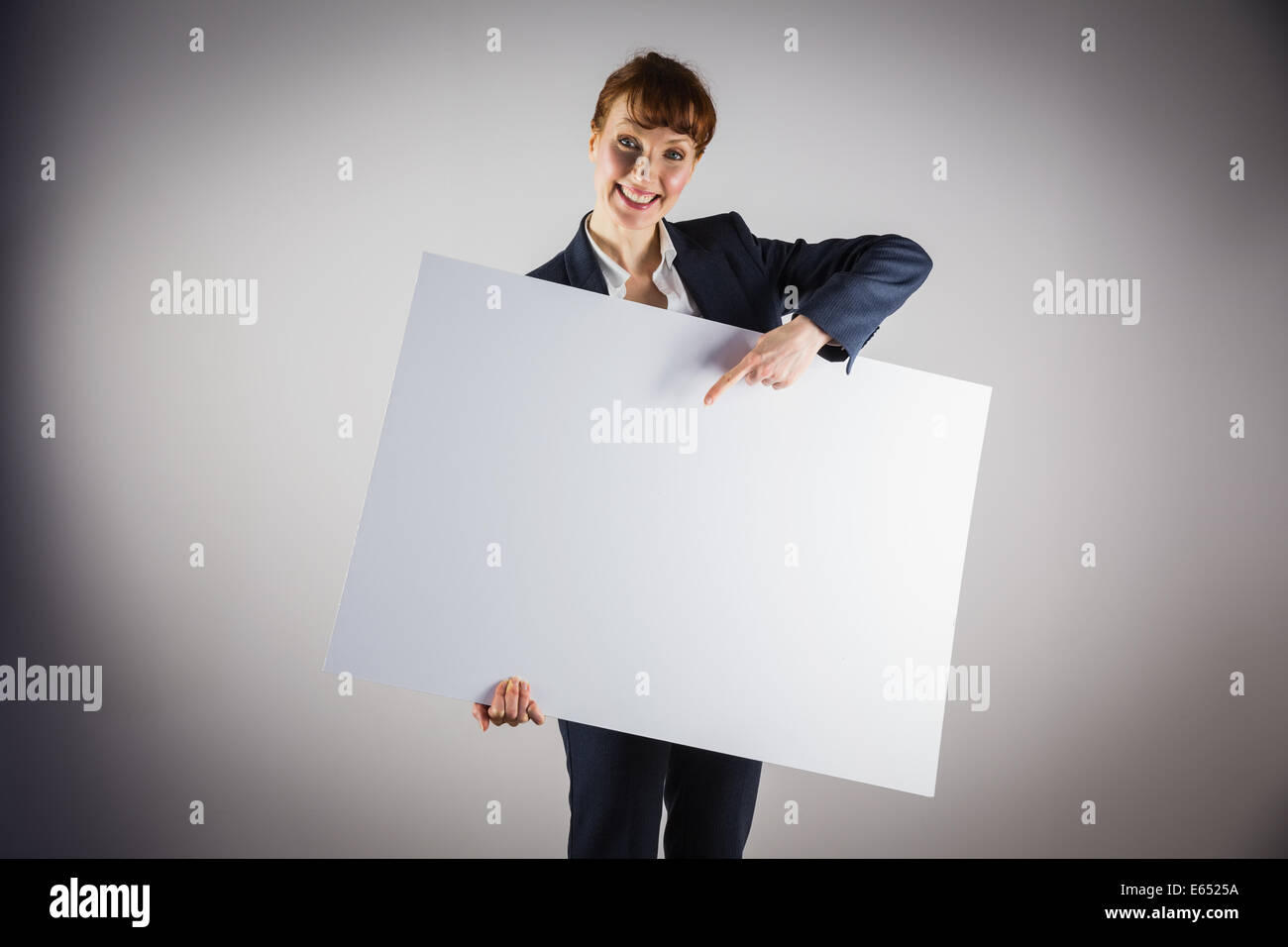 Smiling Businesswoman Pointing White Poster High Resolution Stock ...