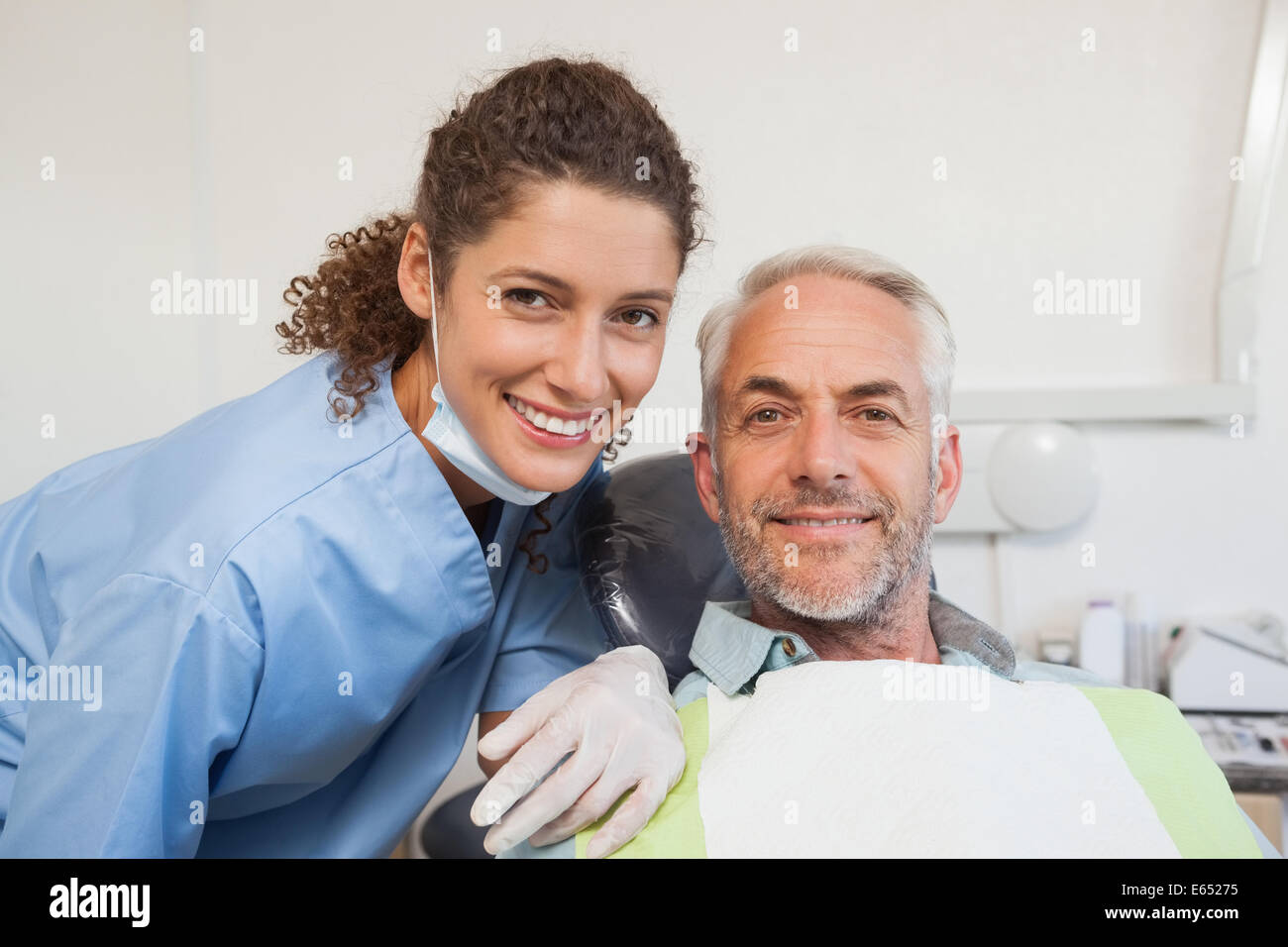 Dentist and patient smiling at camera Stock Photo - Alamy
