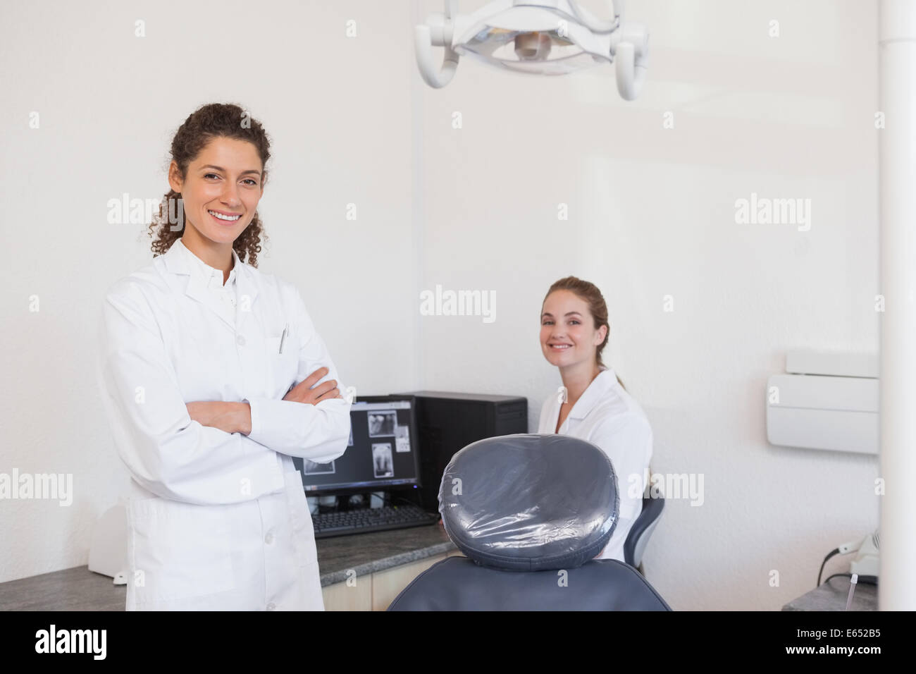 Dentist and assistant smiling at camera Stock Photo - Alamy