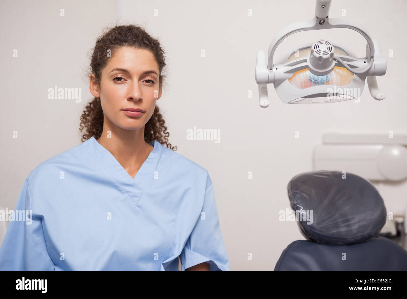 Dentist in blue scrubs looking at camera Stock Photo - Alamy