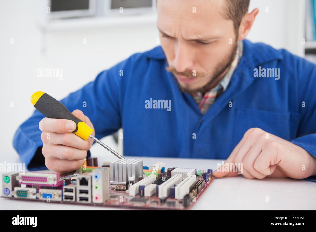 Computer engineer working on cpu with screwdriver Stock Photo - Alamy