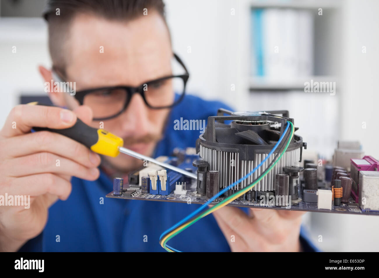 Computer engineer working on cpu with screwdriver Stock Photo - Alamy