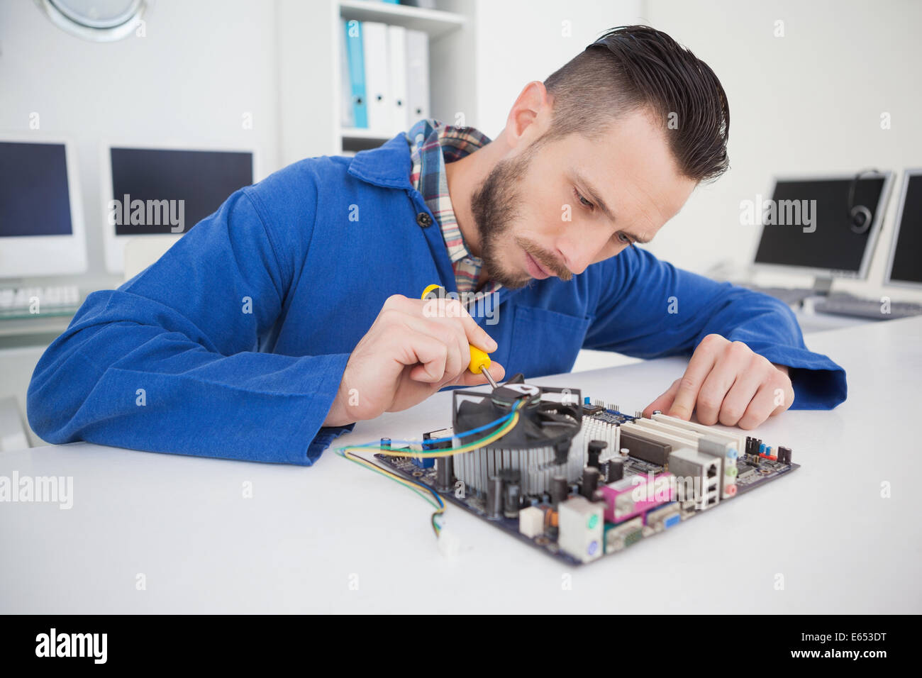 Computer engineer working on cpu with screwdriver Stock Photo - Alamy