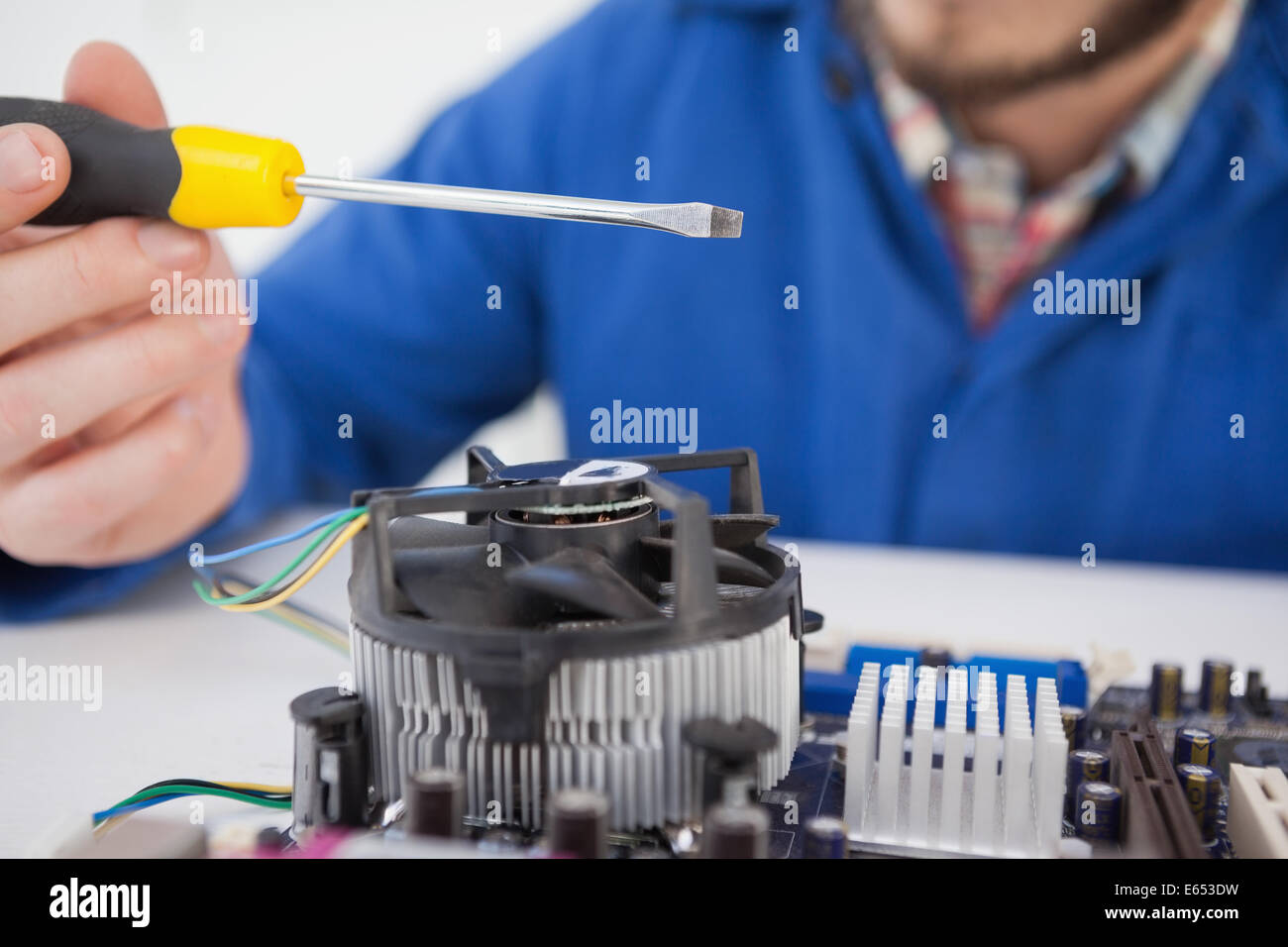 Computer engineer working on cpu with screwdriver Stock Photo - Alamy