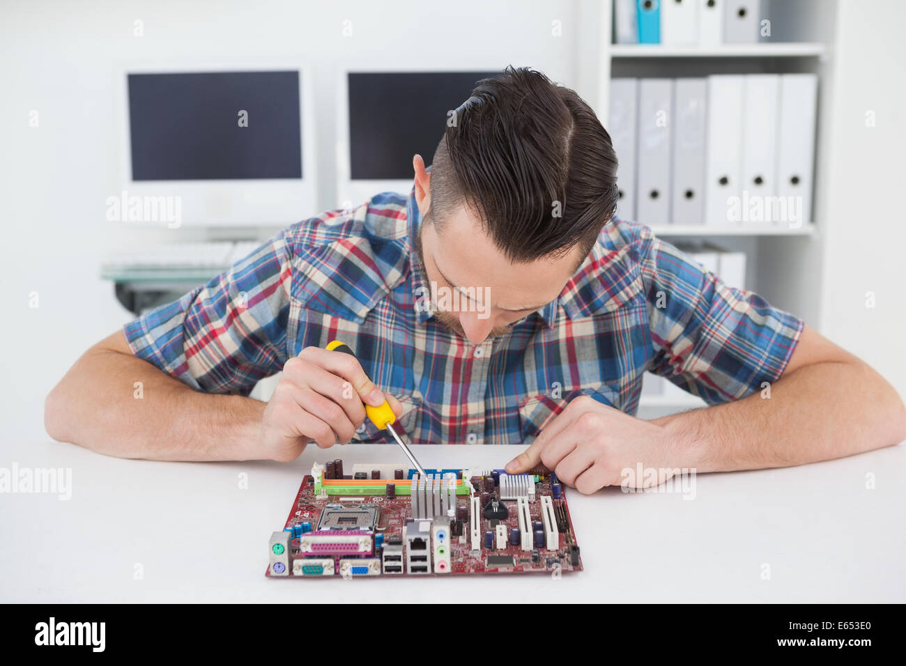 Computer engineer working on cpu with screwdriver Stock Photo - Alamy