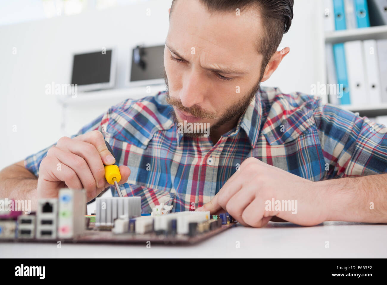 Computer engineer working on cpu with screwdriver Stock Photo - Alamy
