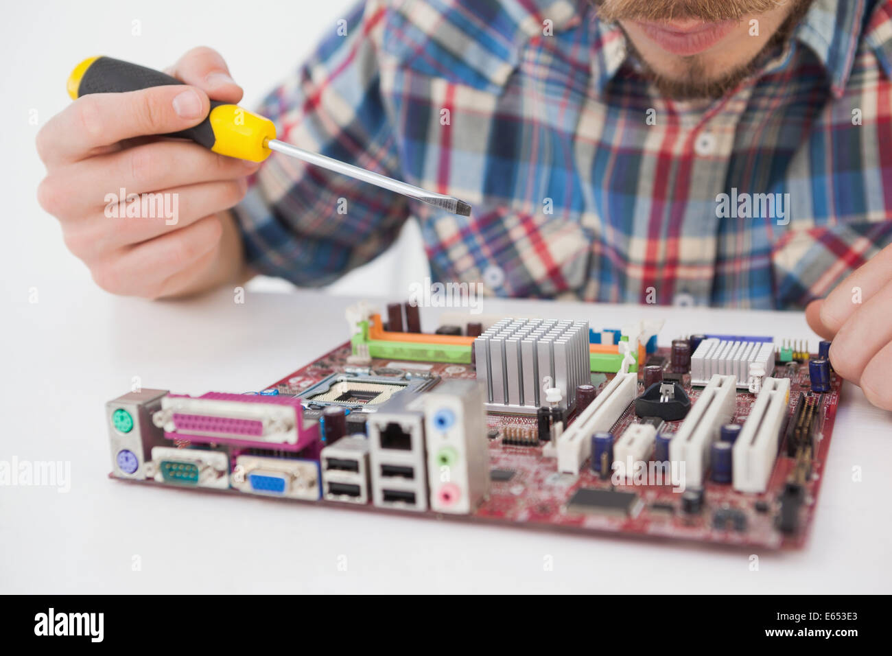 Computer engineer working on cpu with screwdriver Stock Photo - Alamy