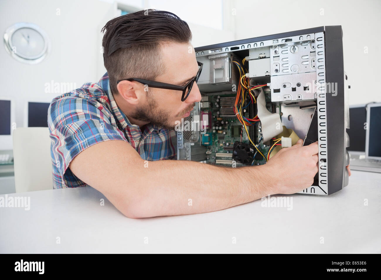 Computer engineer working on broken console Stock Photo - Alamy