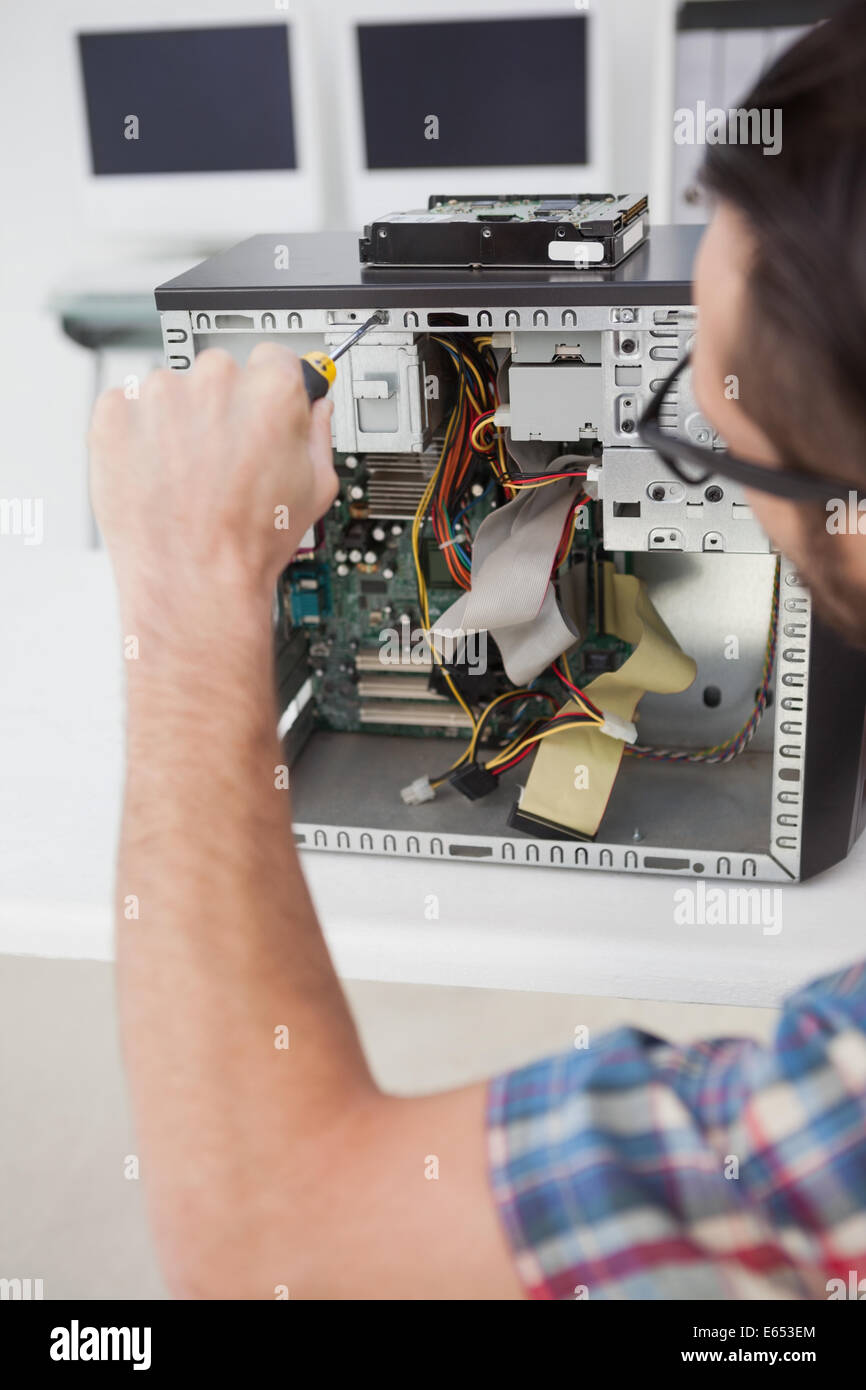 Computer engineer working on broken console with screwdriver Stock ...
