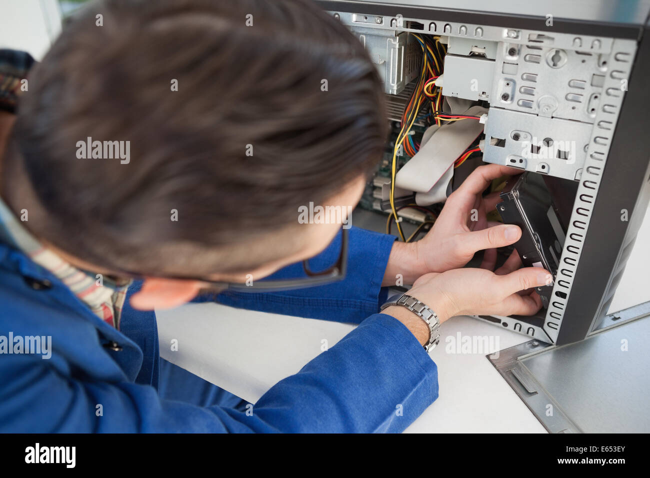 Computer engineer working on broken console Stock Photo - Alamy