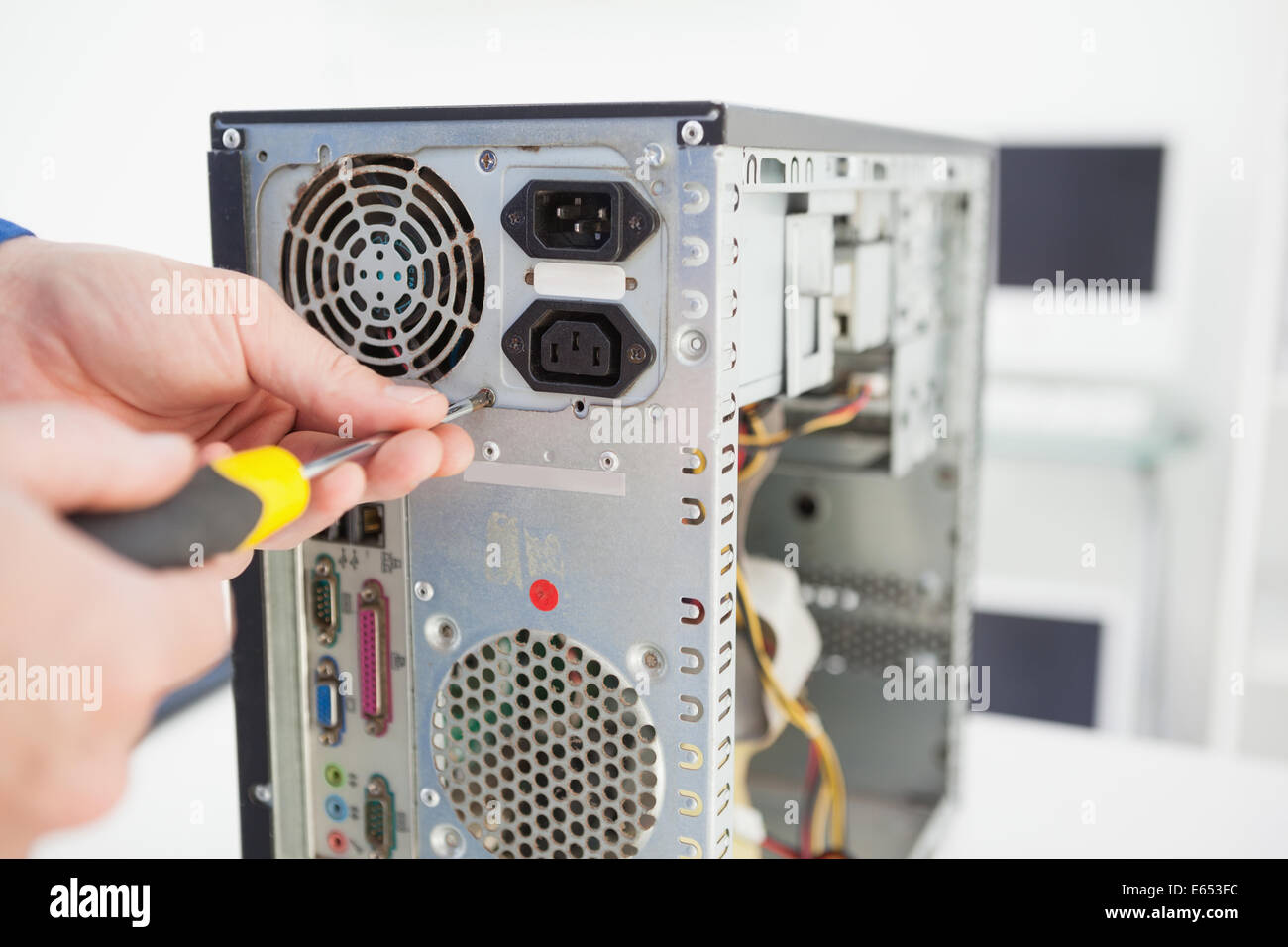 Computer engineer working on broken console with screwdriver Stock ...