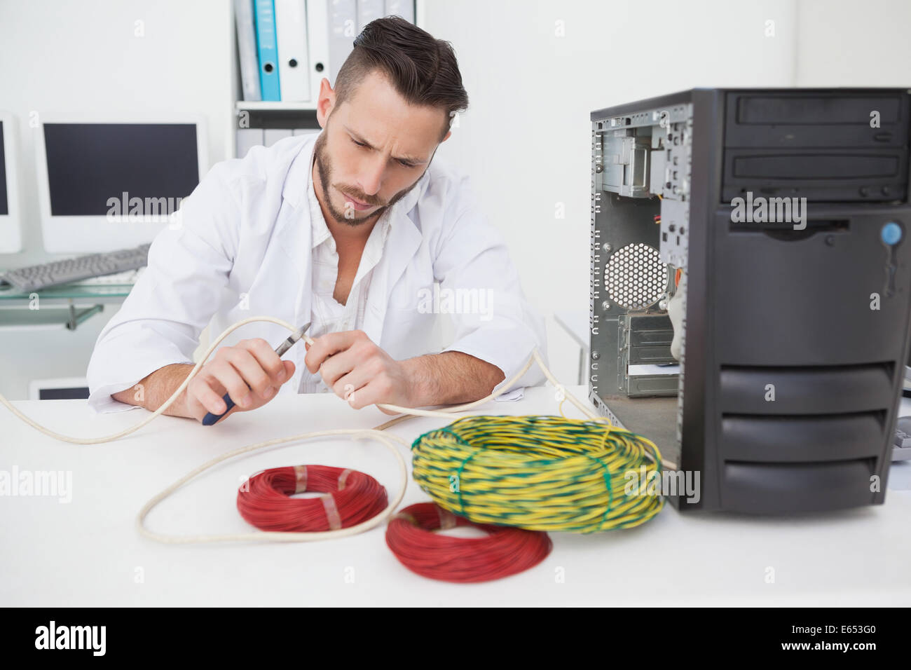 Computer engineer working on broken cables Stock Photo - Alamy