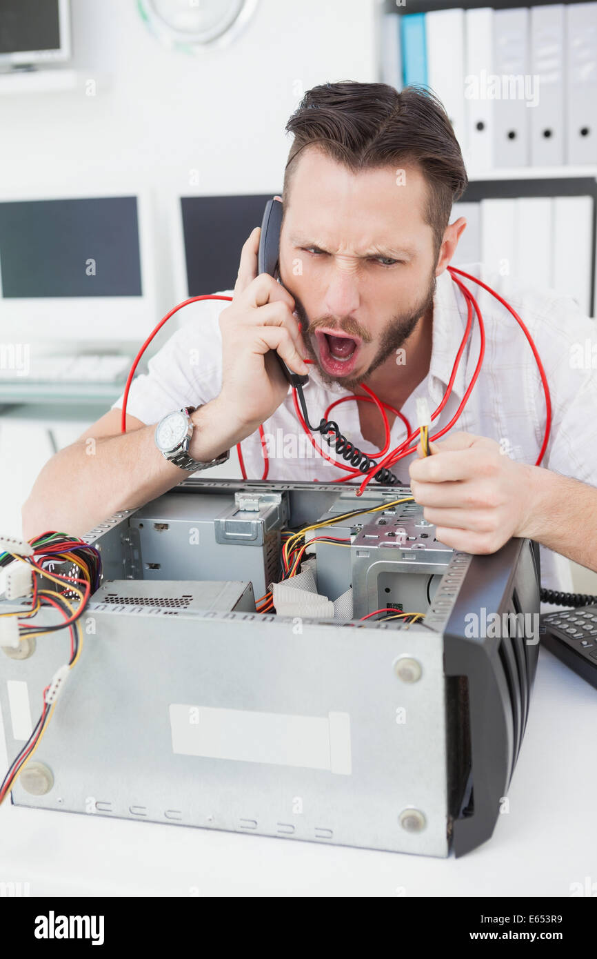 Angry computer engineer making a call Stock Photo - Alamy
