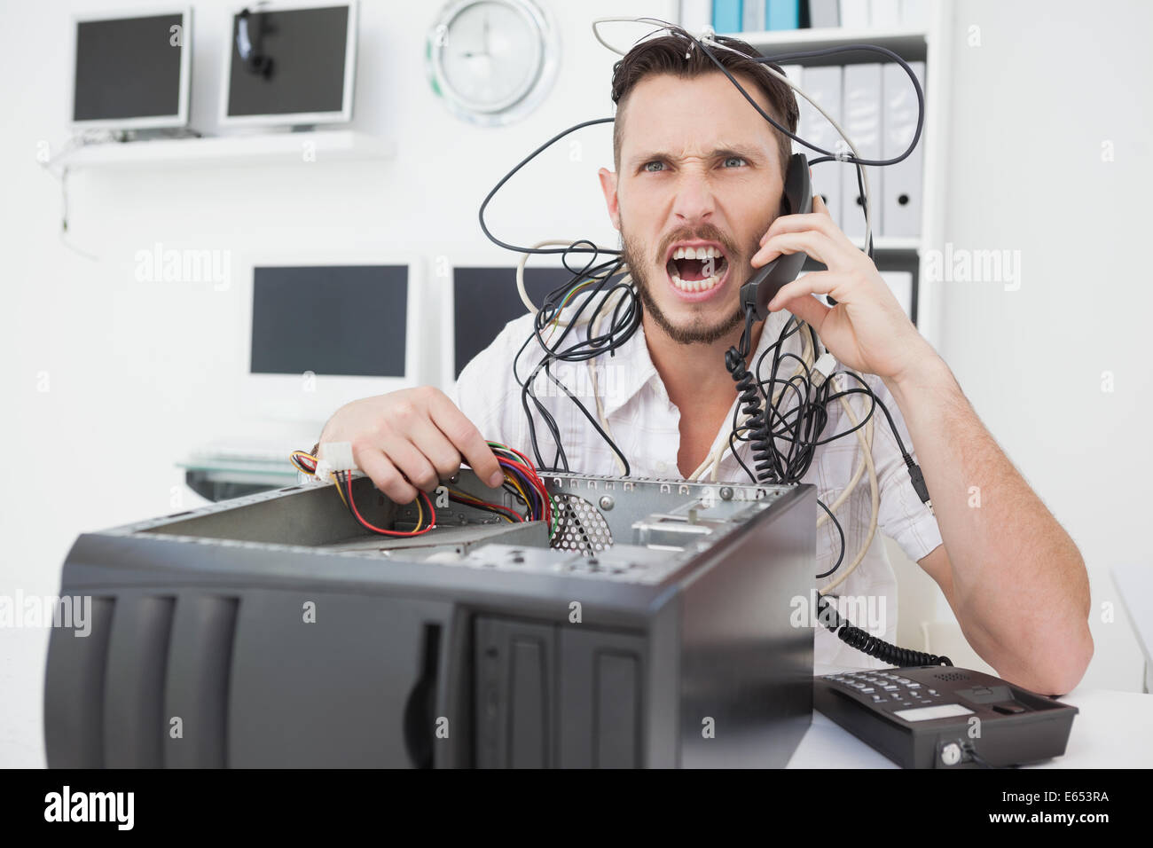Angry computer engineer making a call Stock Photo - Alamy