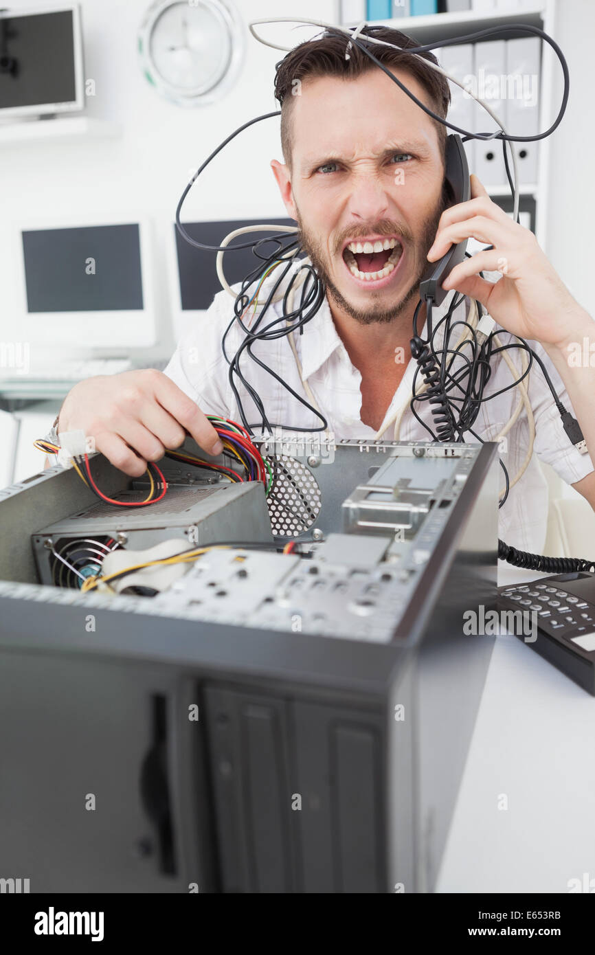 Angry computer engineer making a call Stock Photo - Alamy